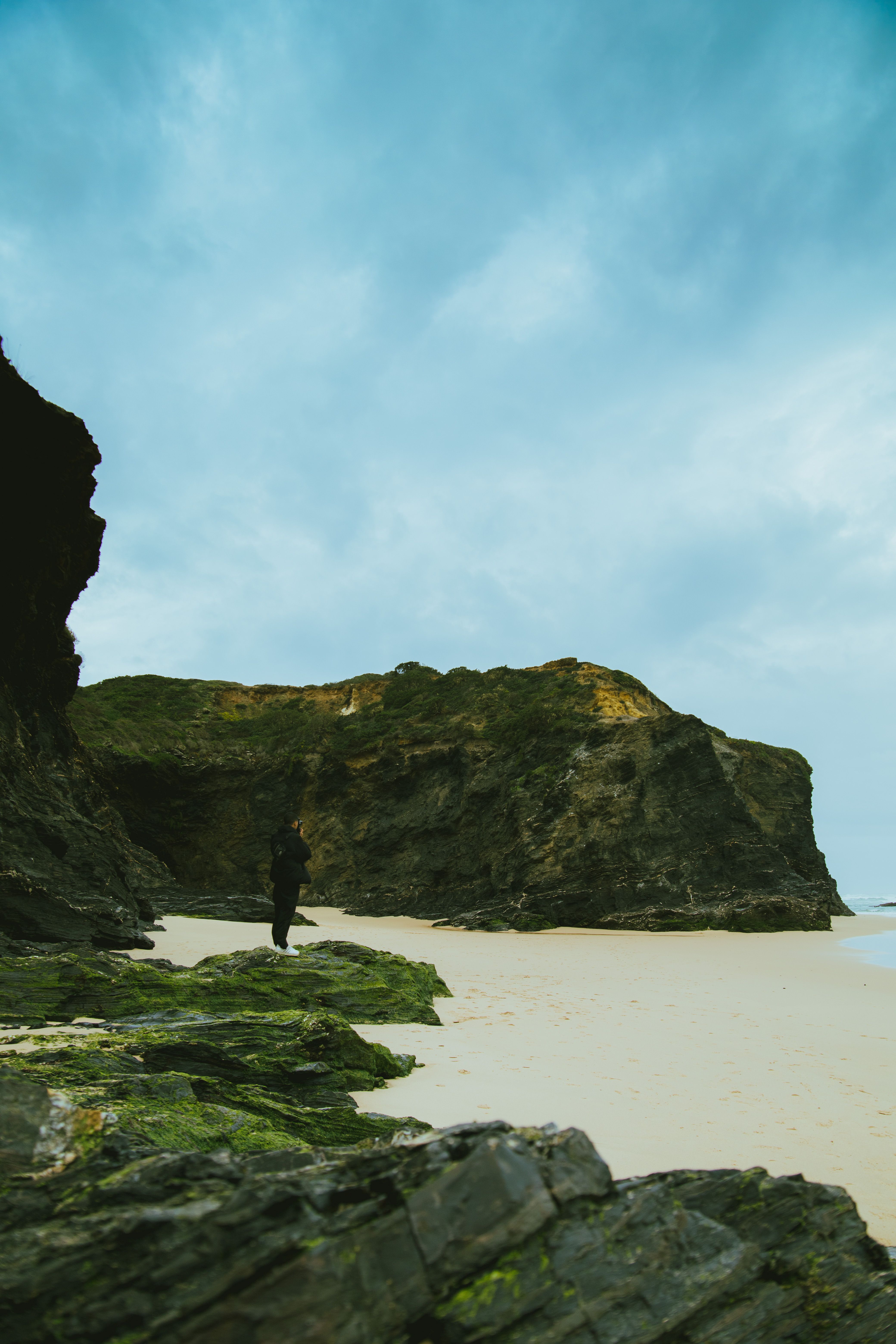 A Cliff Near a Sea Under Blue Sky · Free Stock Photo