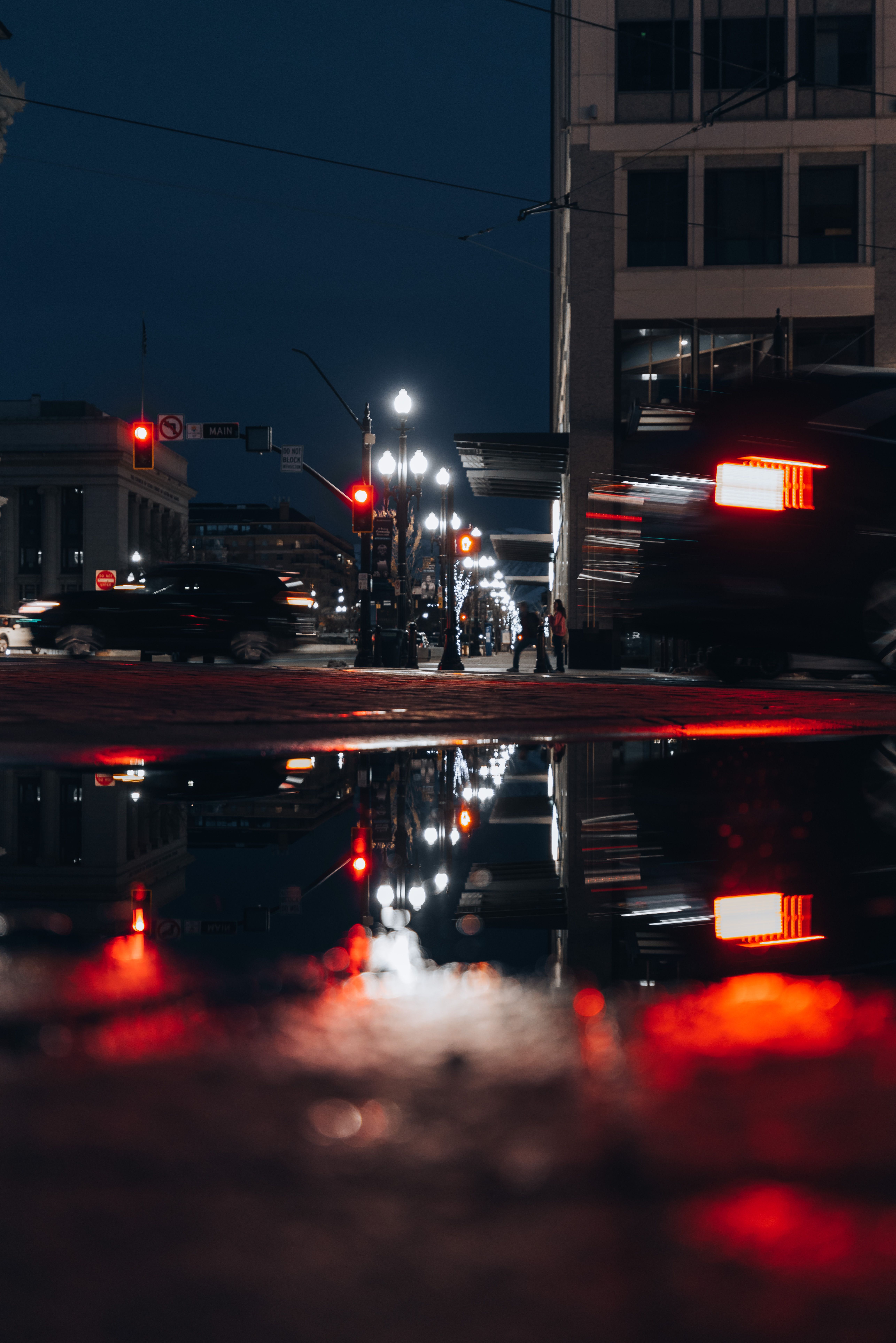 City Buildings Reflected in a Puddle at Dusk · Free Stock Photo