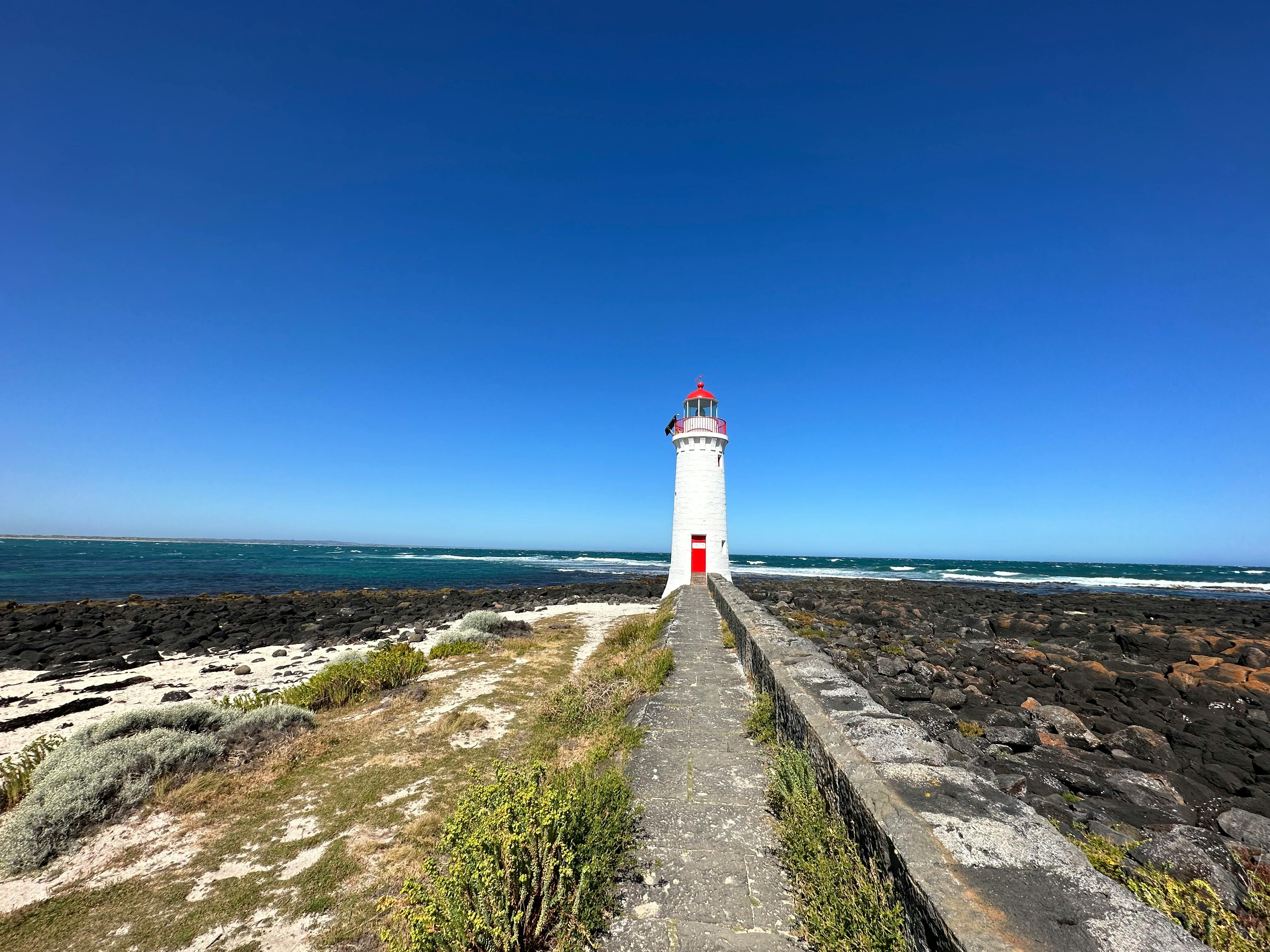 Lighthouse on Beach · Free Stock Photo