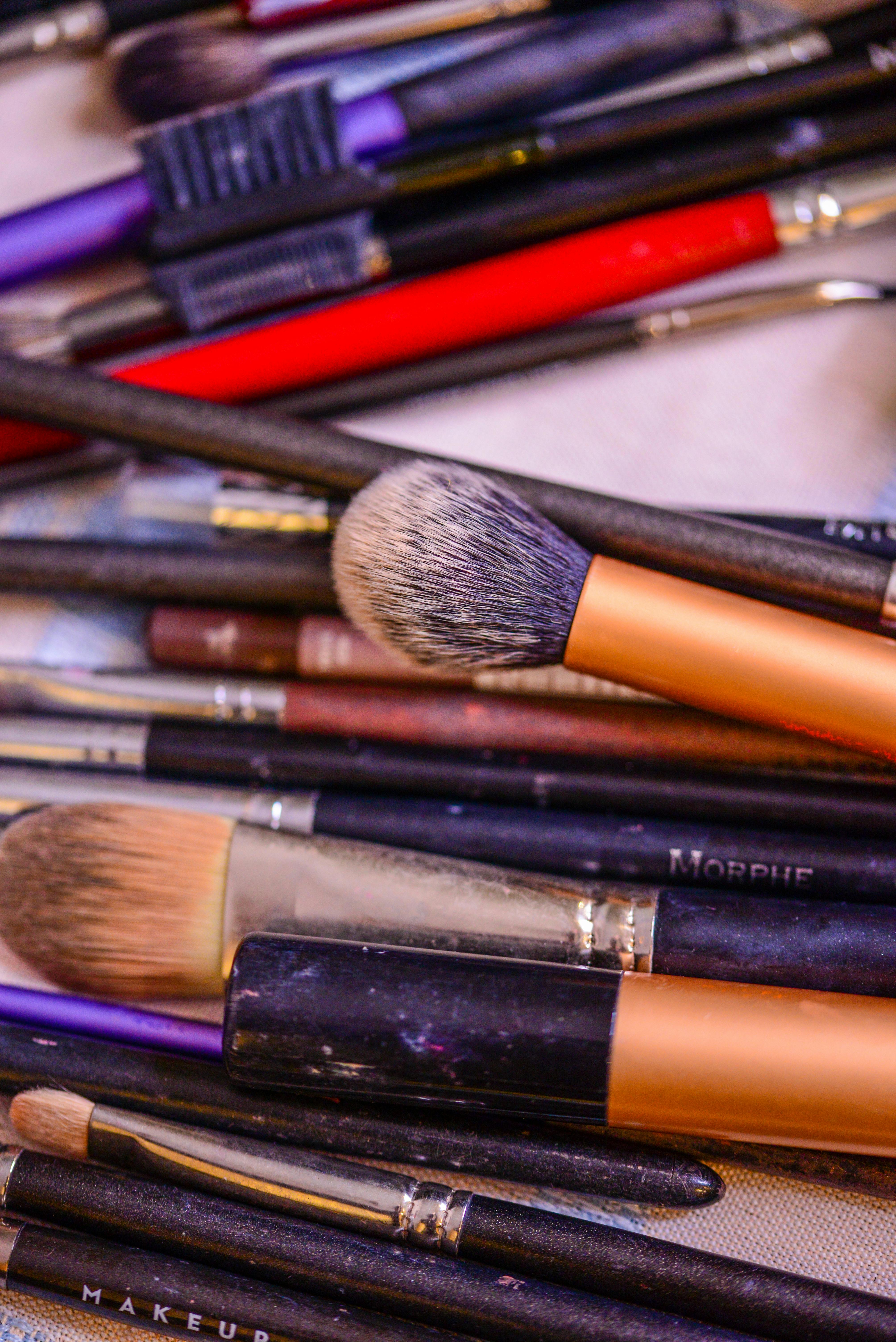 Cosmetics Makeup Brushes and Powder Dust Explosion · Free Stock Photo