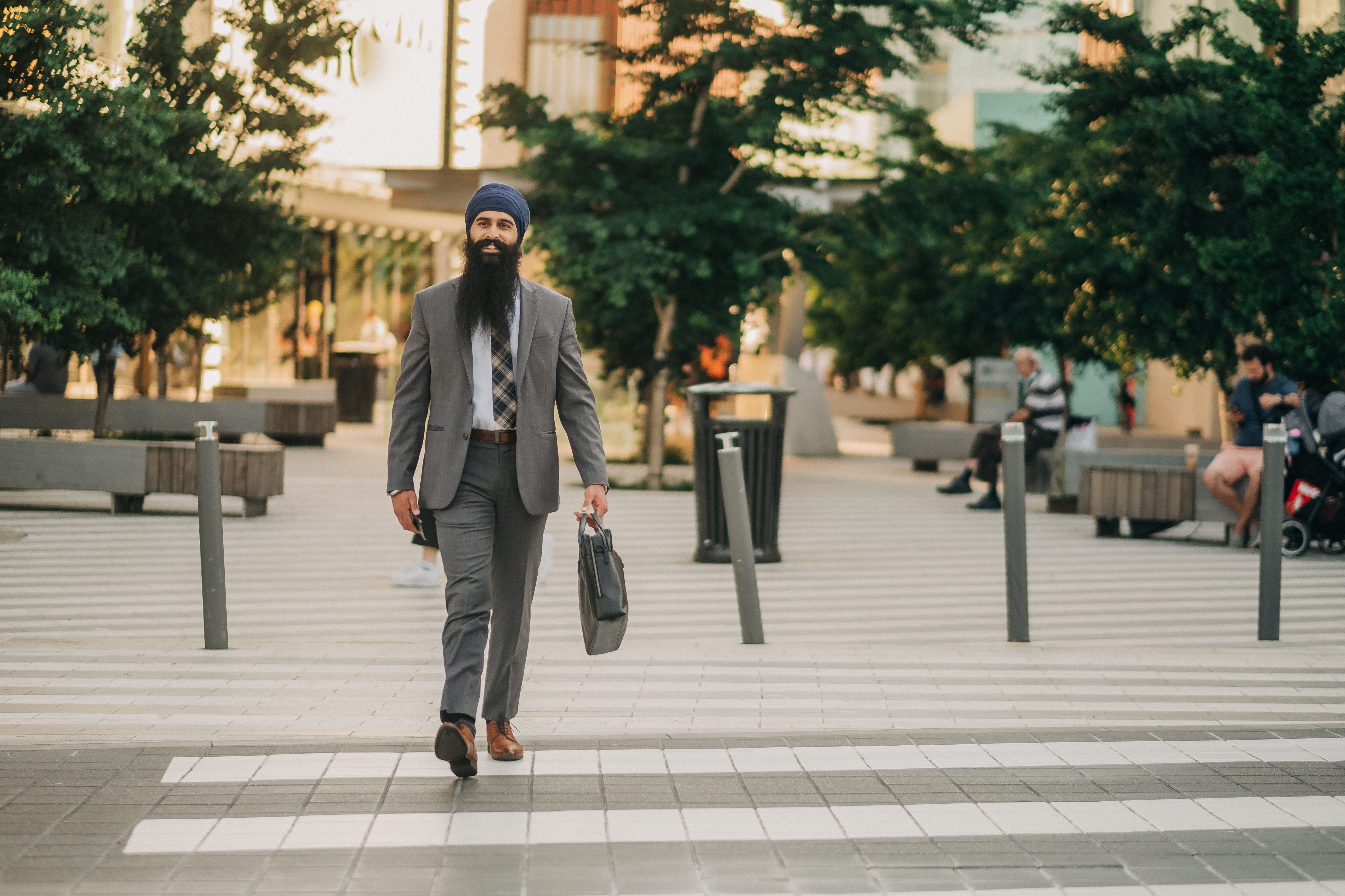 A Bearded Man in Gray Suit and Pants Walking on the Street while ...