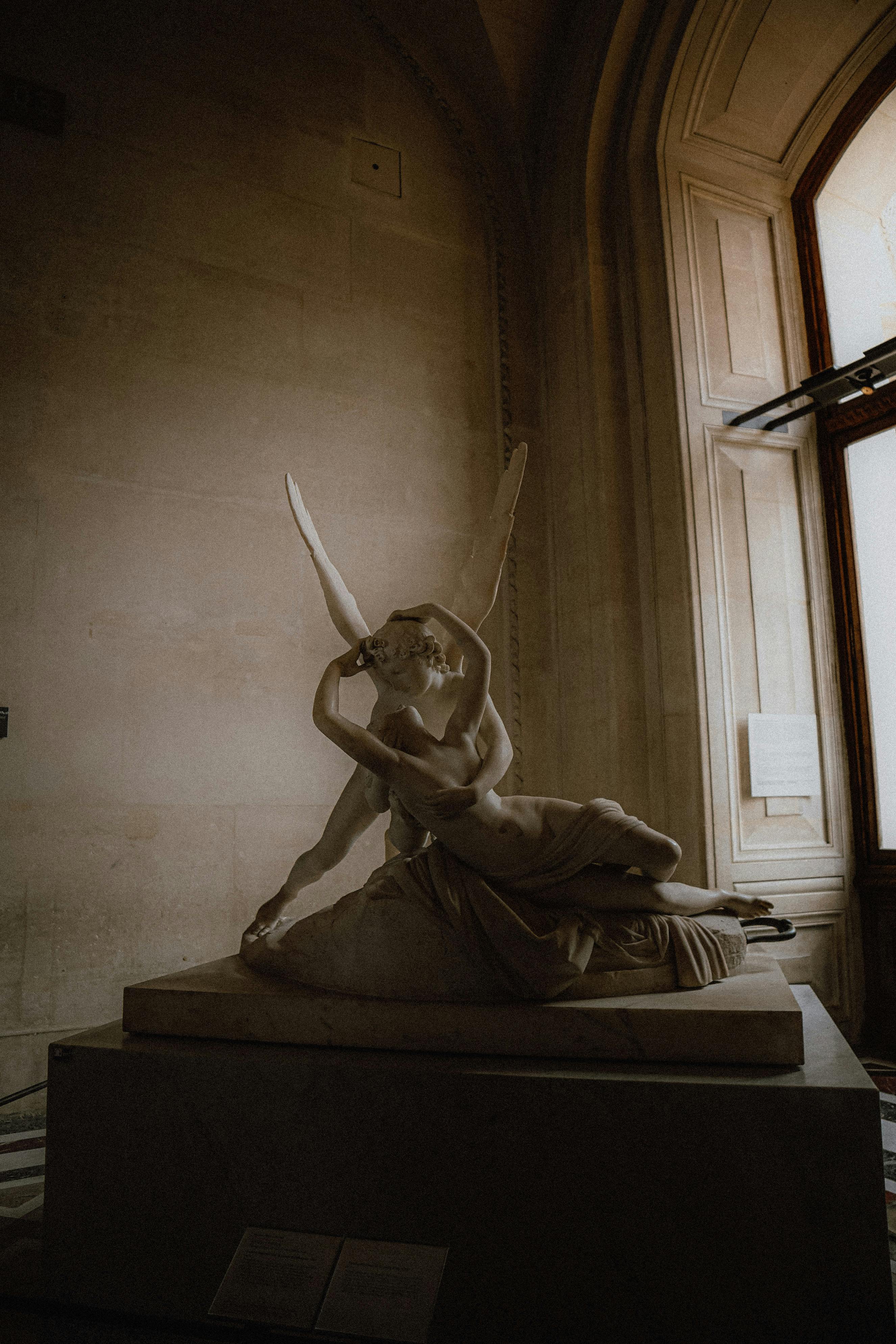 Statues Next to Window · Free Stock Photo