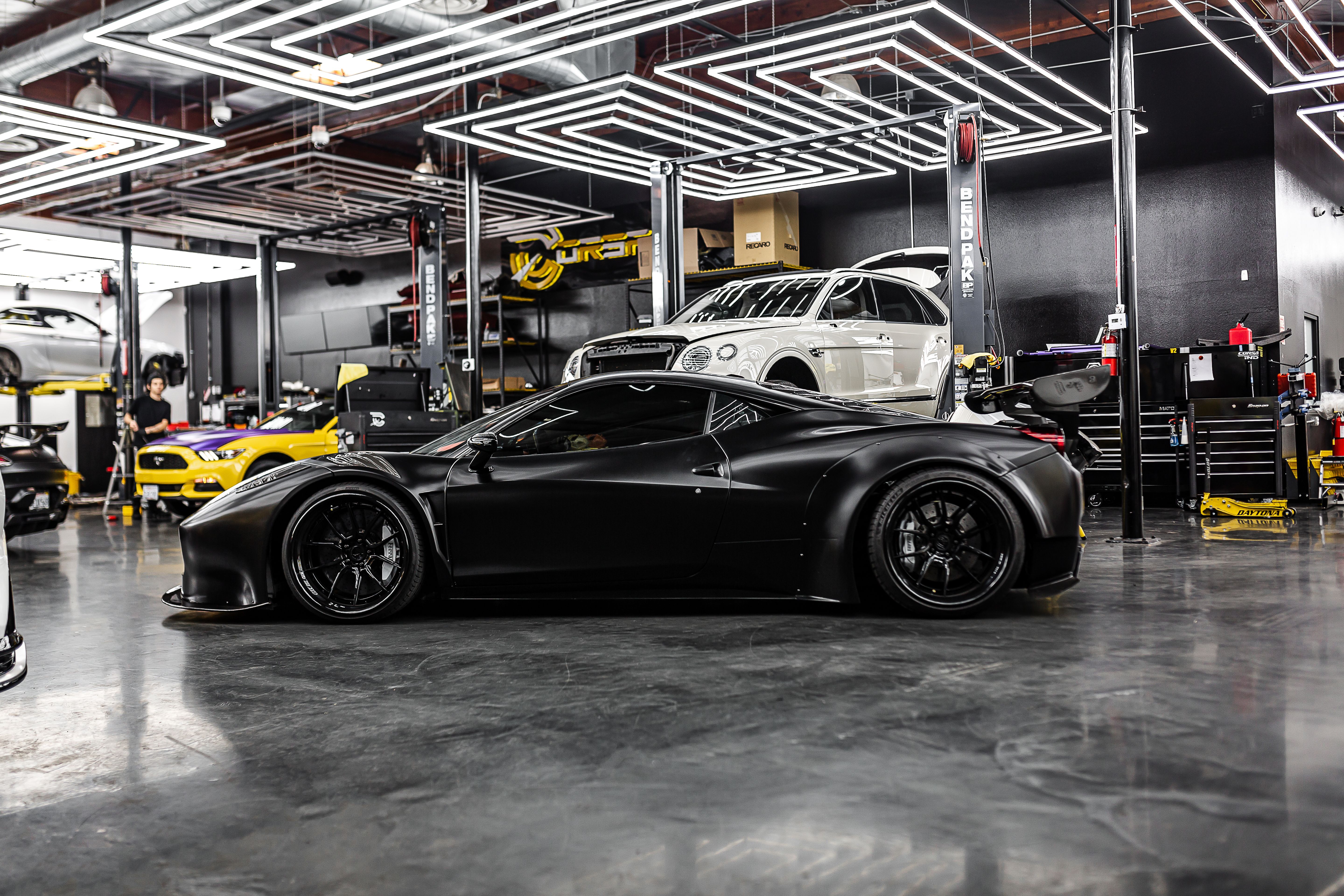 Black Sports Car in an Auto Repair Shop · Free Stock Photo