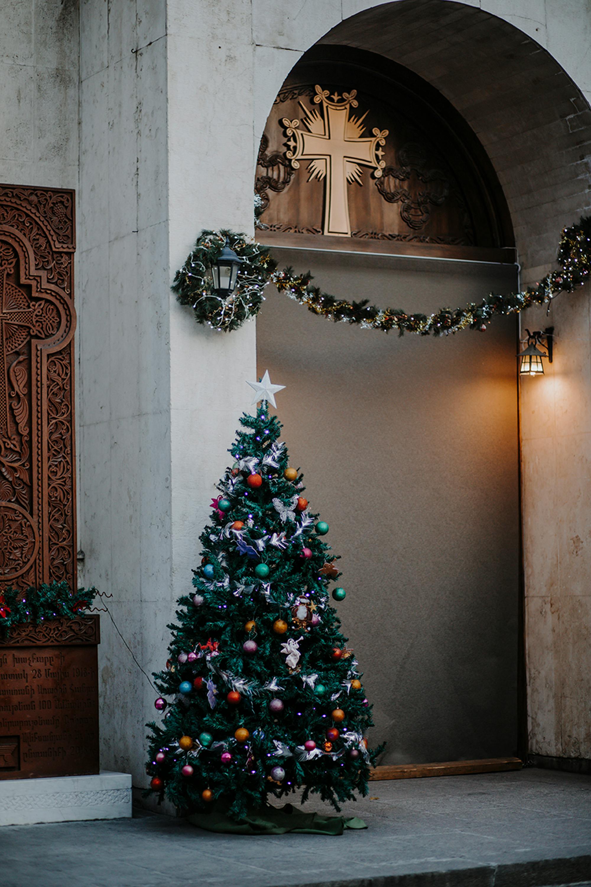 Decorated Christmas Tree in front of Church · Free Stock Photo