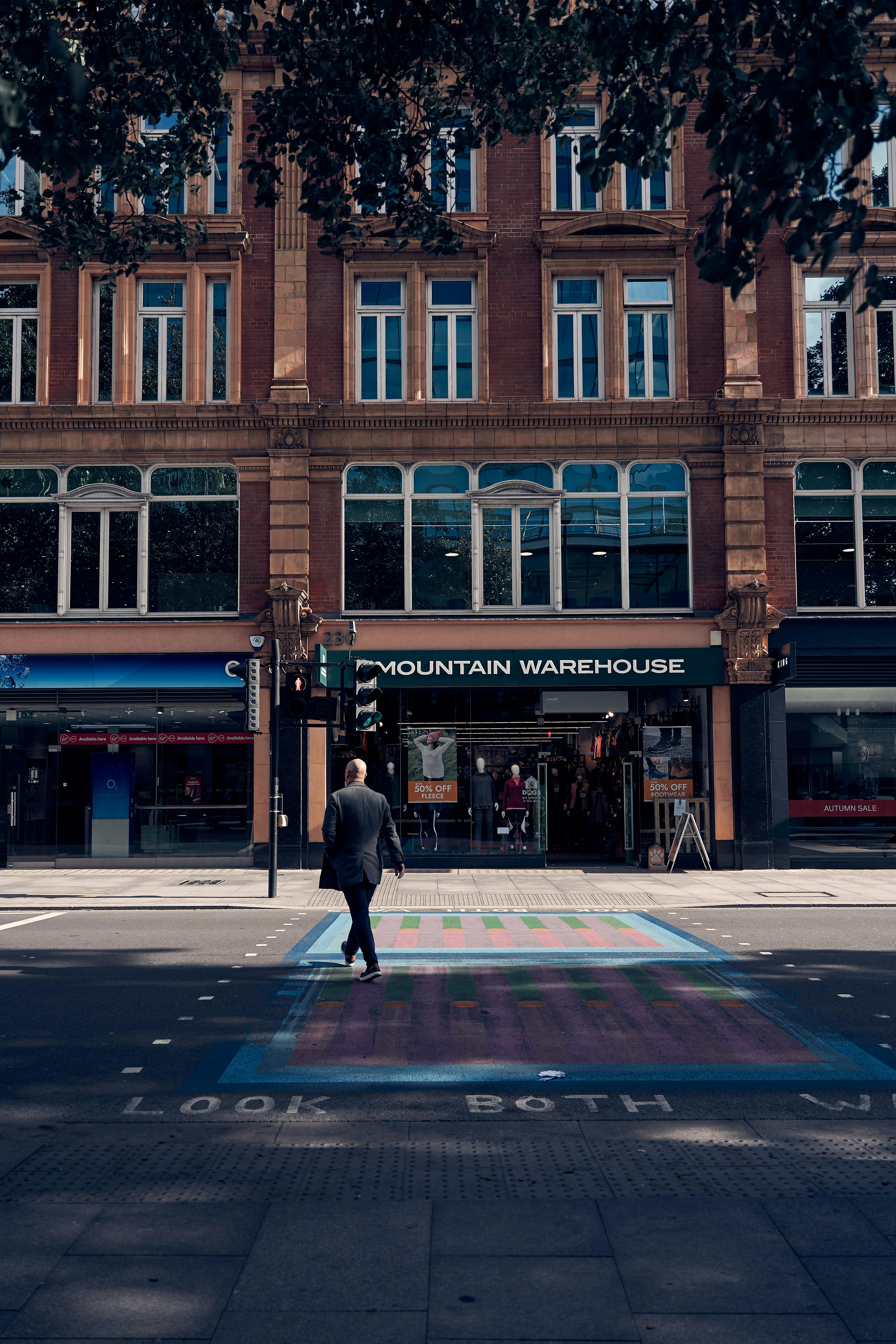 A Back View of a Man Walking on the Street · Free Stock Photo