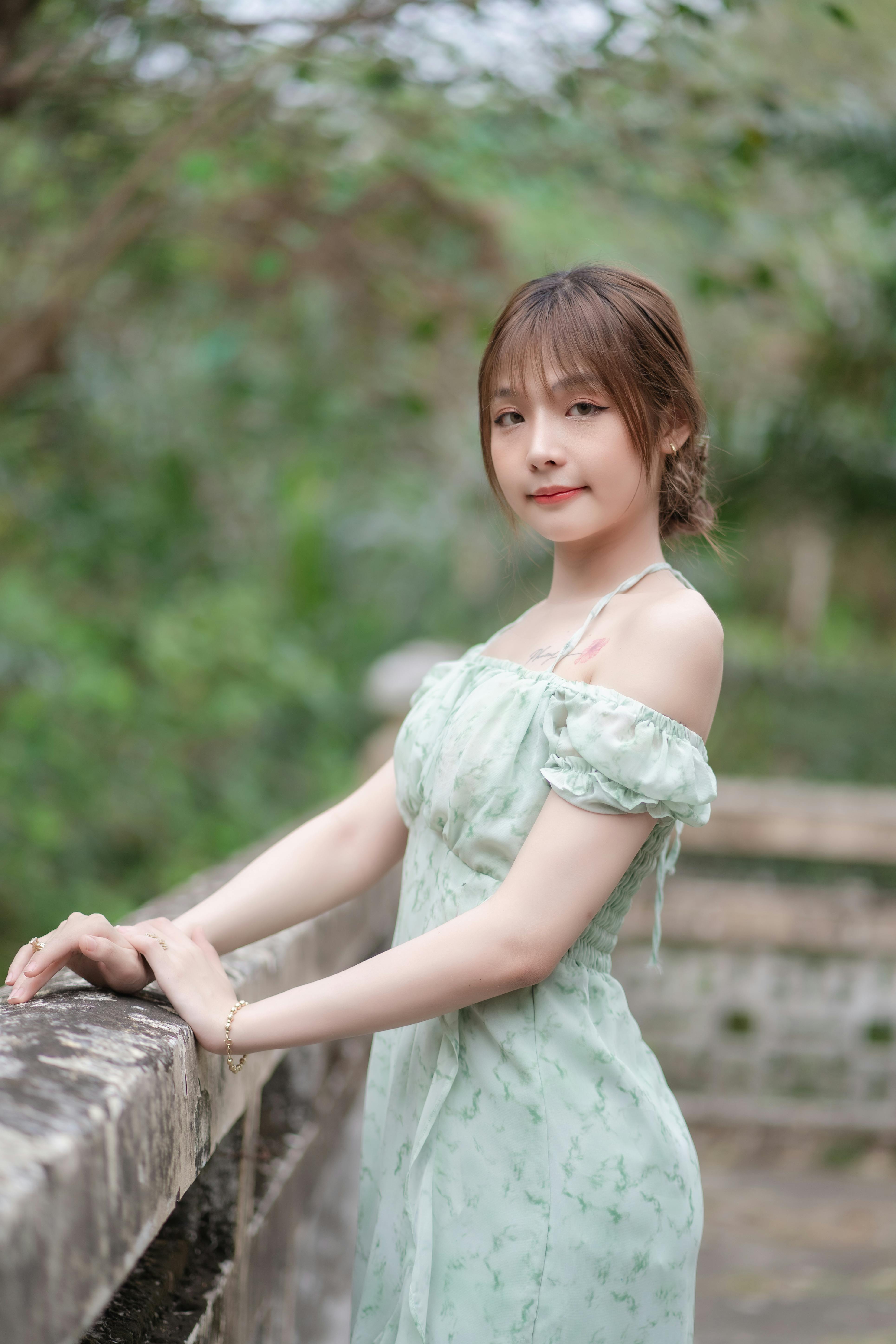 Woman in White Dress Standing Beside the Green Plant · Free Stock Photo