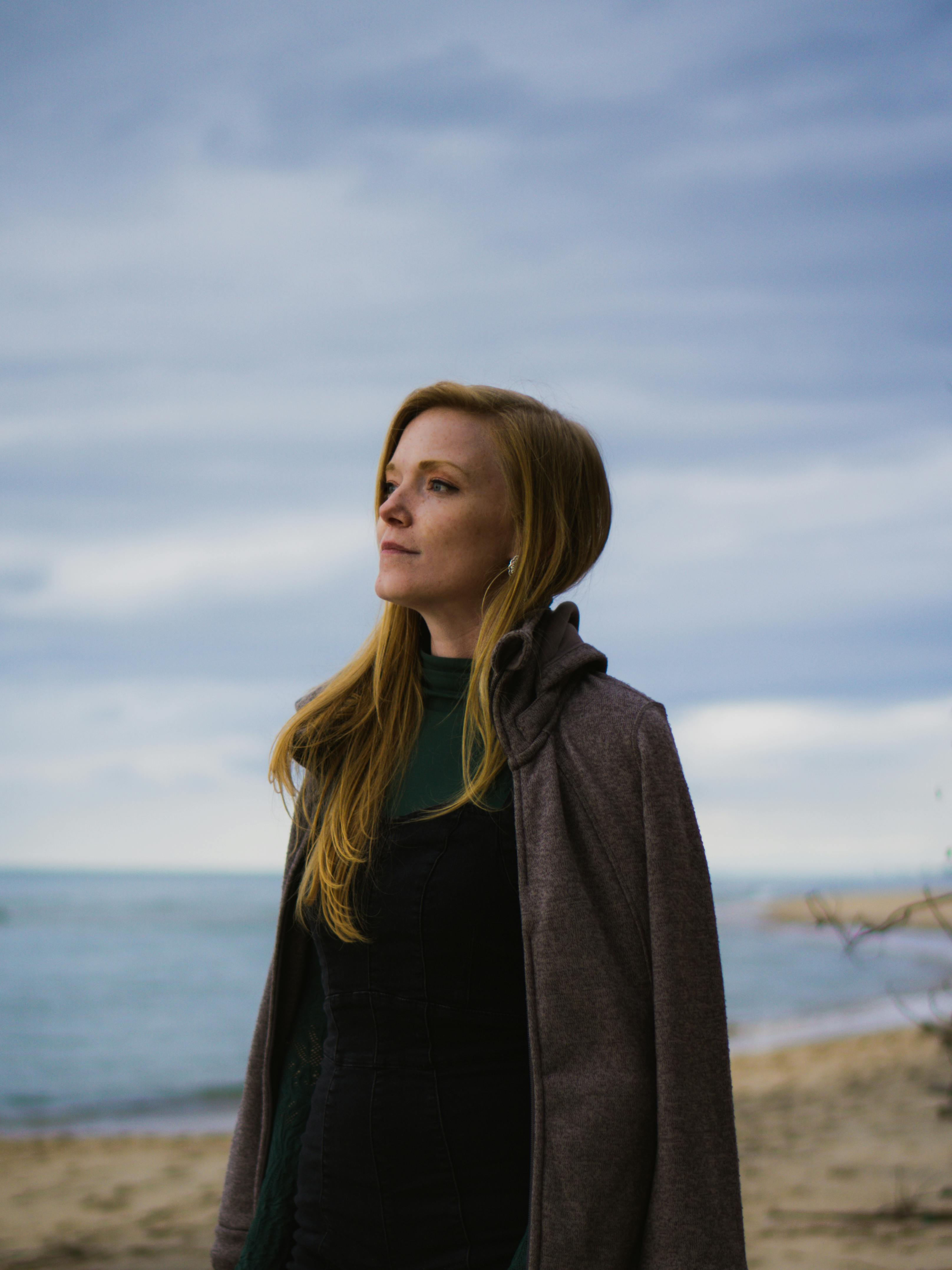 Woman in Gray Sweater Looking Afar · Free Stock Photo