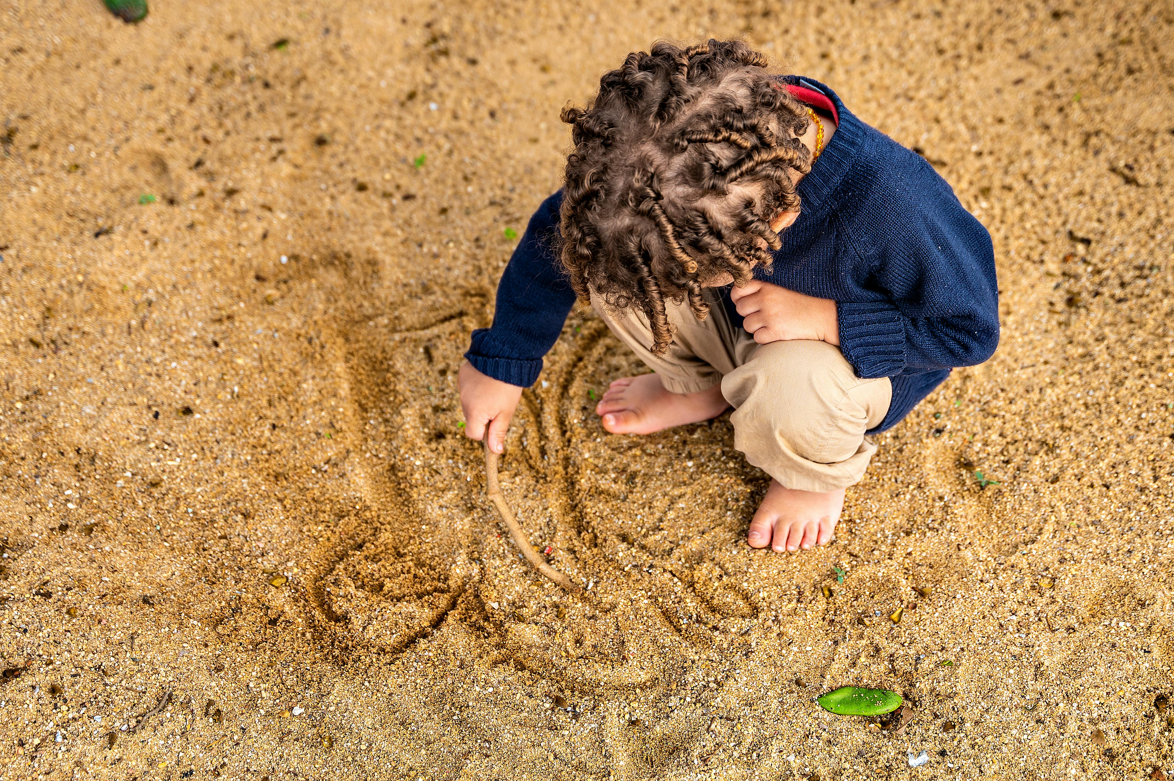 Child Drawing on Sand · Free Stock Photo