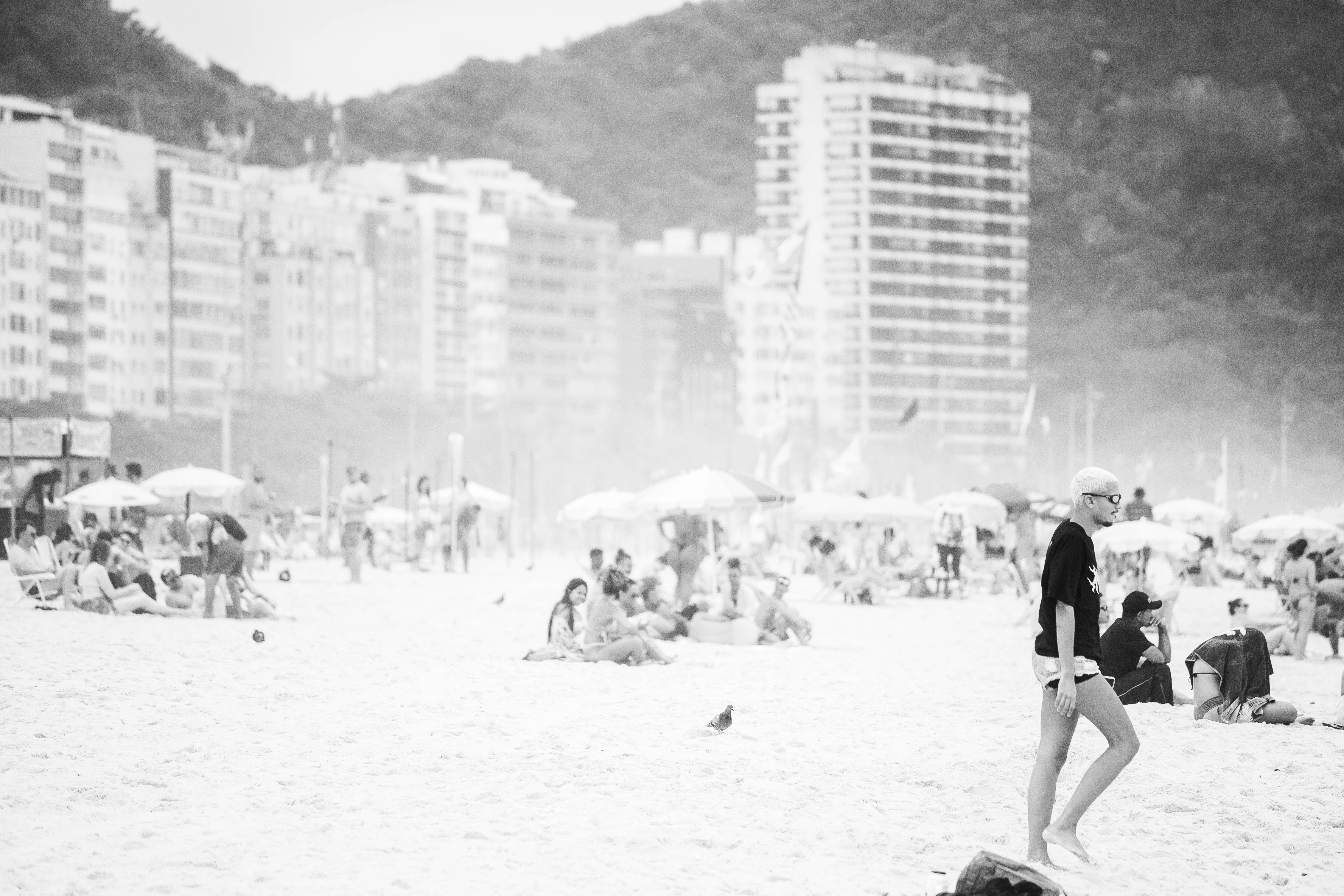 A Grayscale Photo of People on the Beach · Free Stock Photo