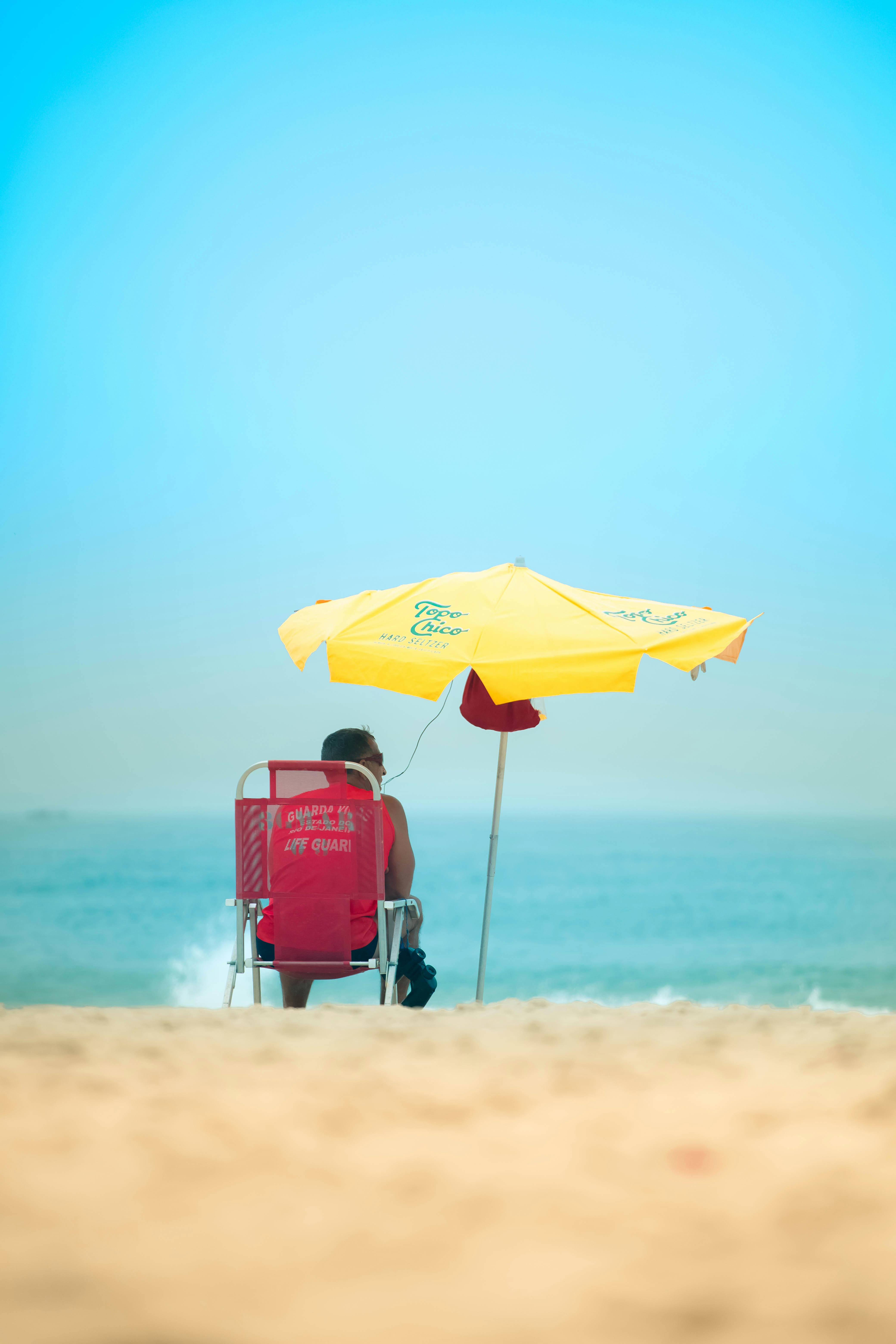 Lifeguard Sitting on the Beach · Free Stock Photo