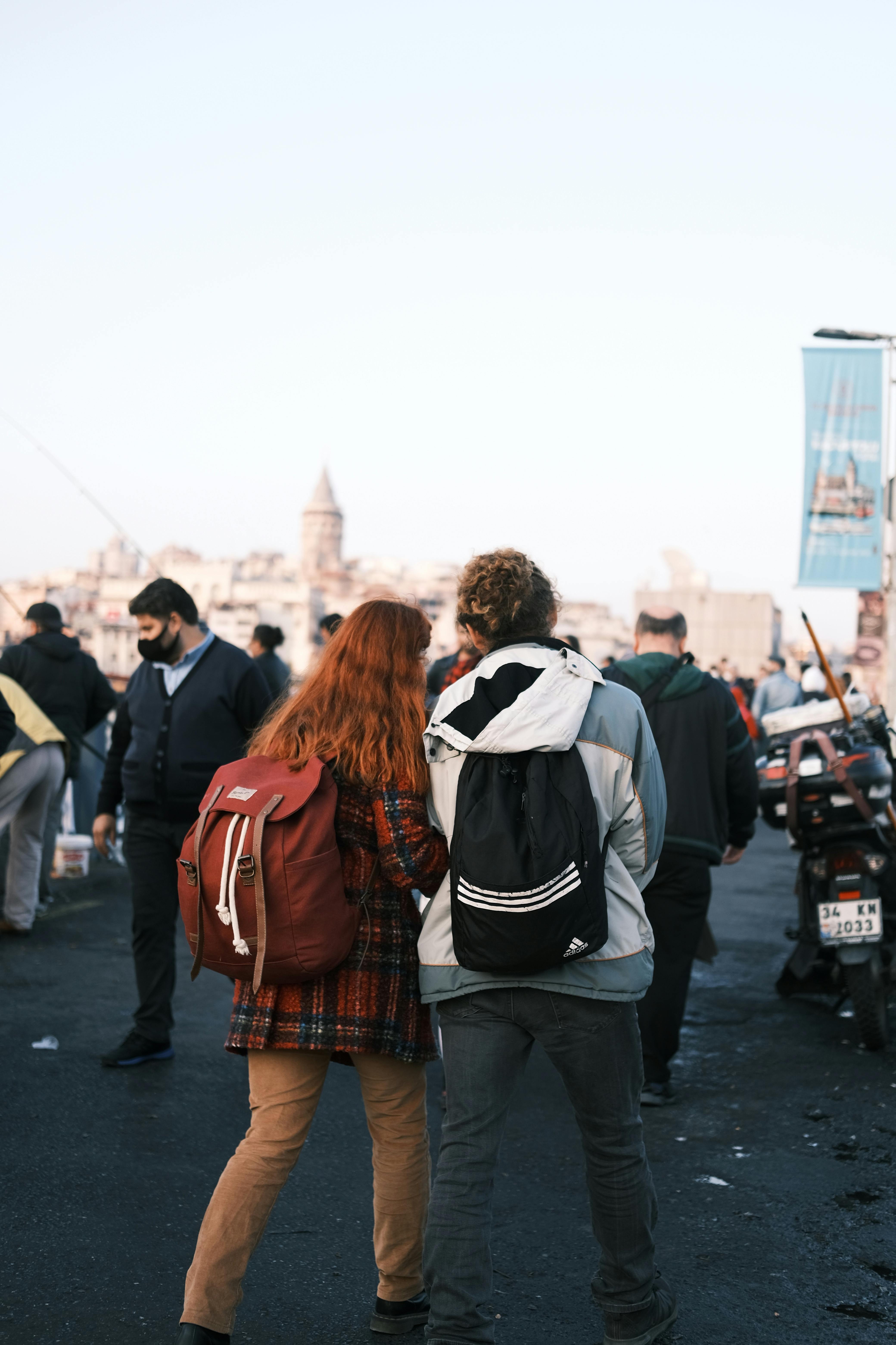 People with Backpacks Walking on Street · Free Stock Photo