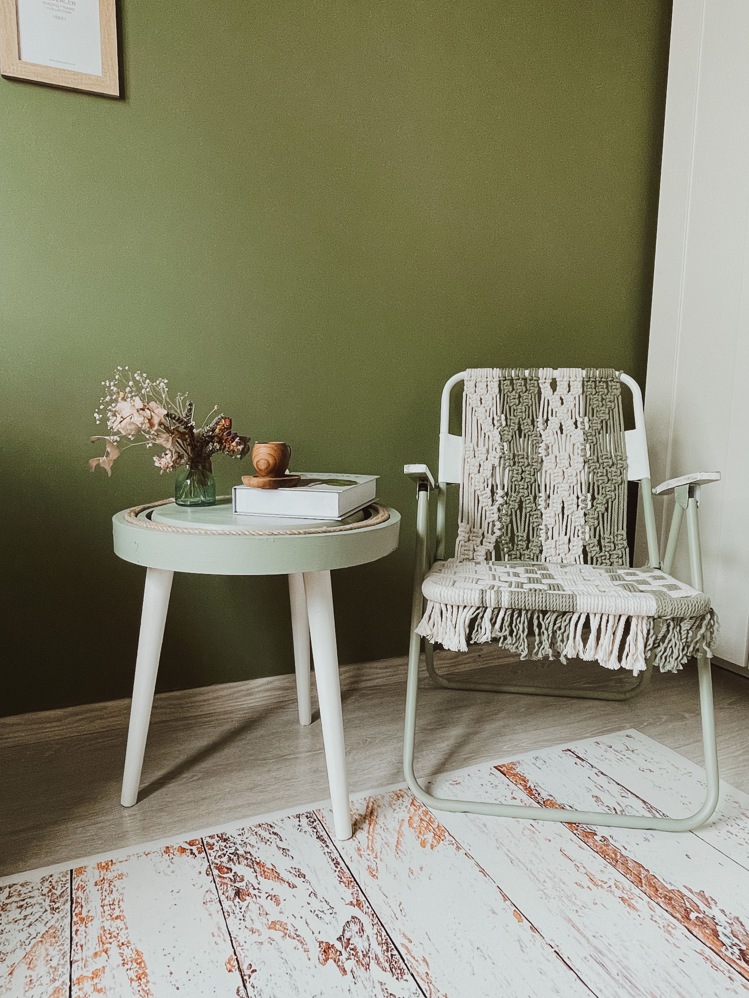 A Chair and Small Table with a Dried Bouquet Standing next to a Green ...