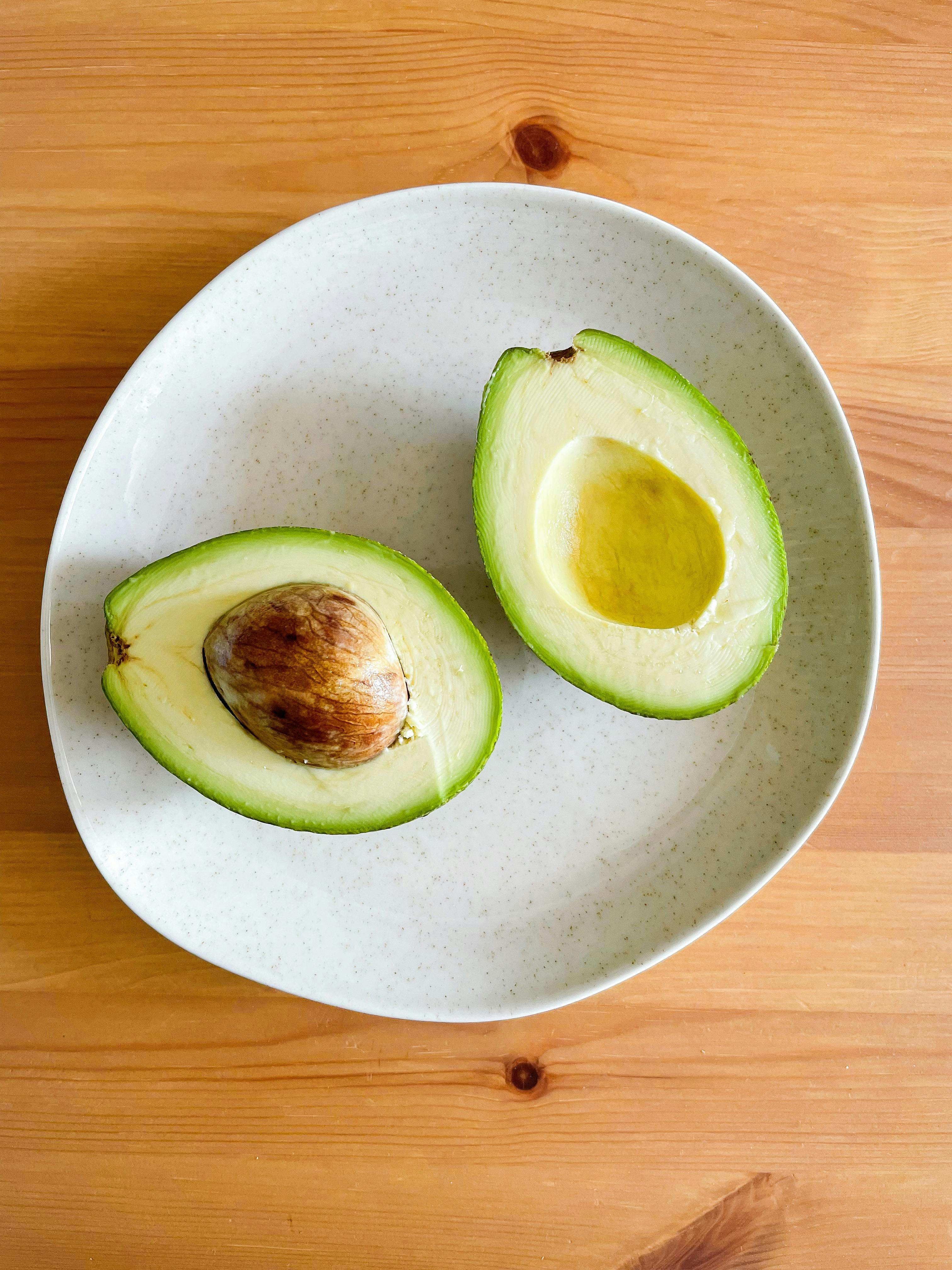 Parts of healthy avocado on plate · Free Stock Photo
