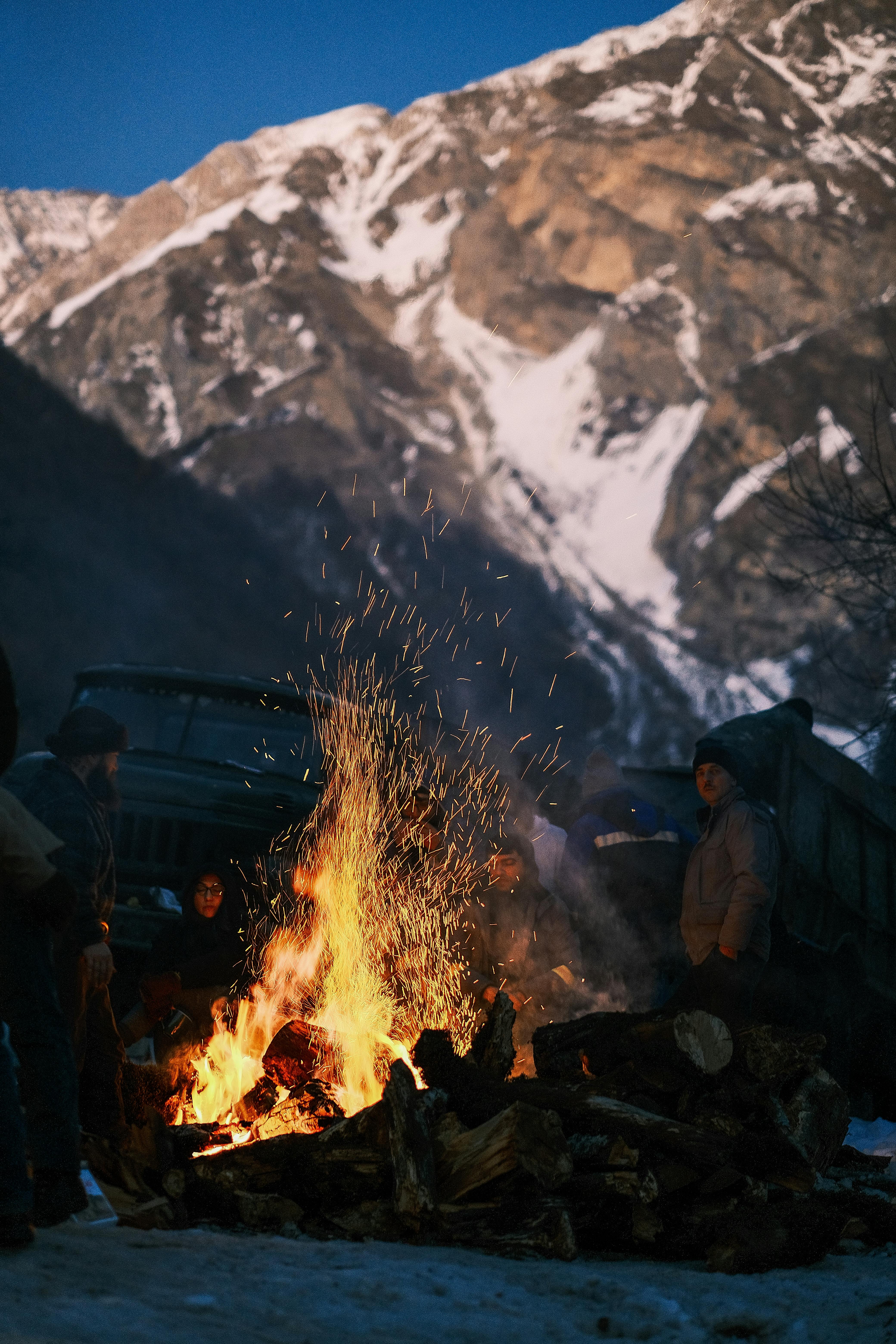 Hand in Glove Holding Kettle over Bonfire in Winter · Free Stock Photo