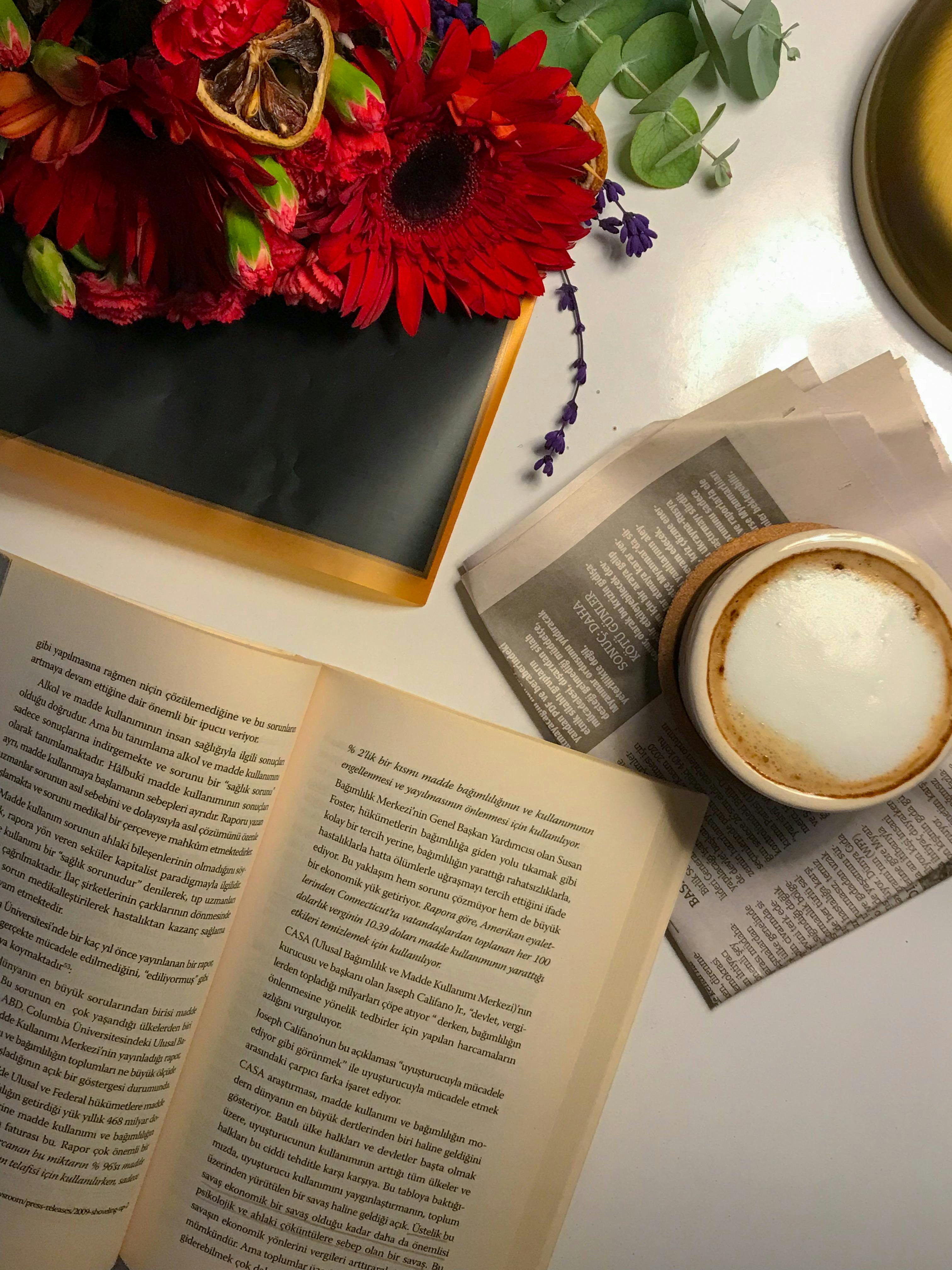 Pink Petals on the Cup of Coffee and Book · Free Stock Photo