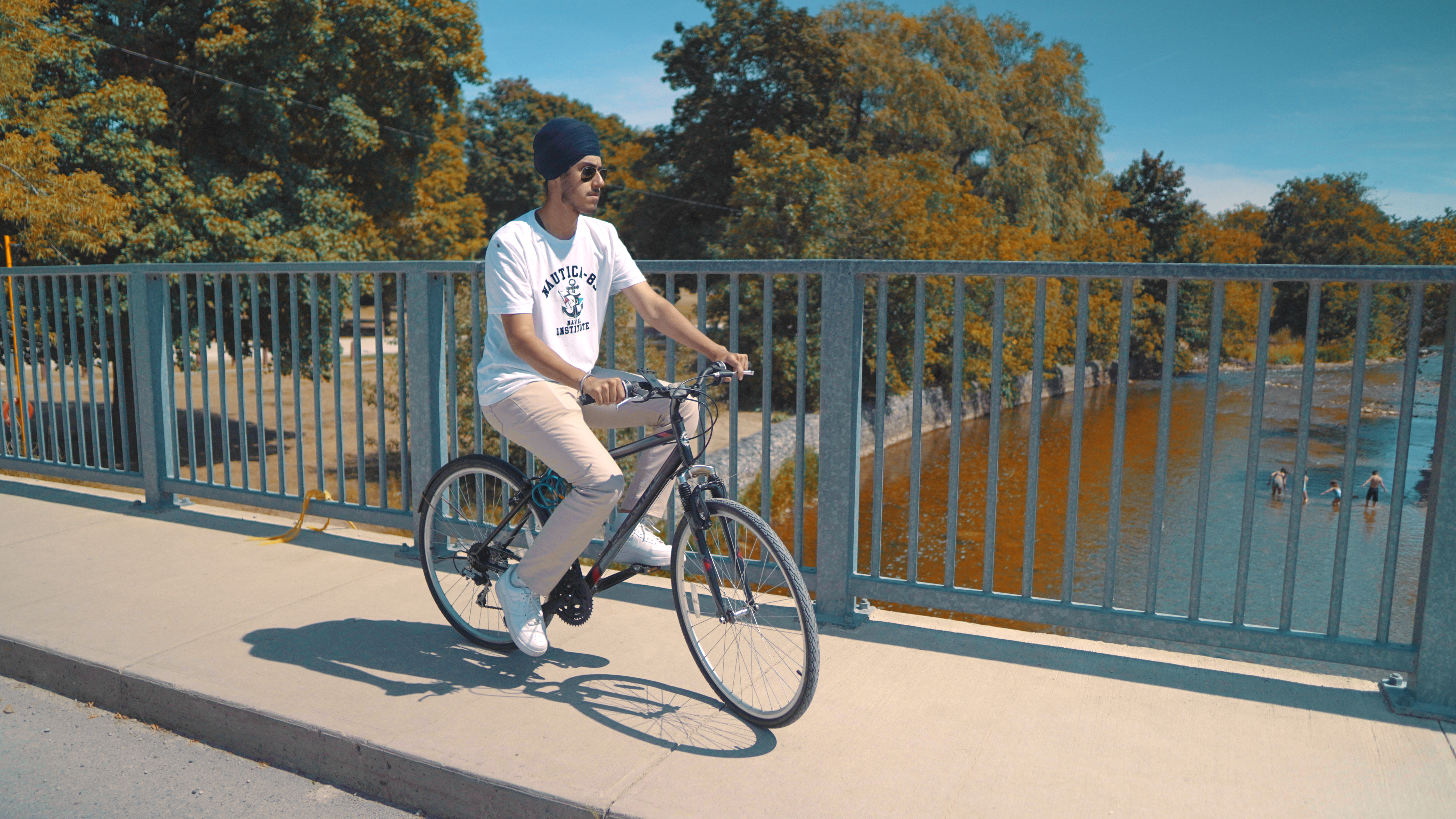 Man in Turban on Bicycle on Bridge · Free Stock Photo