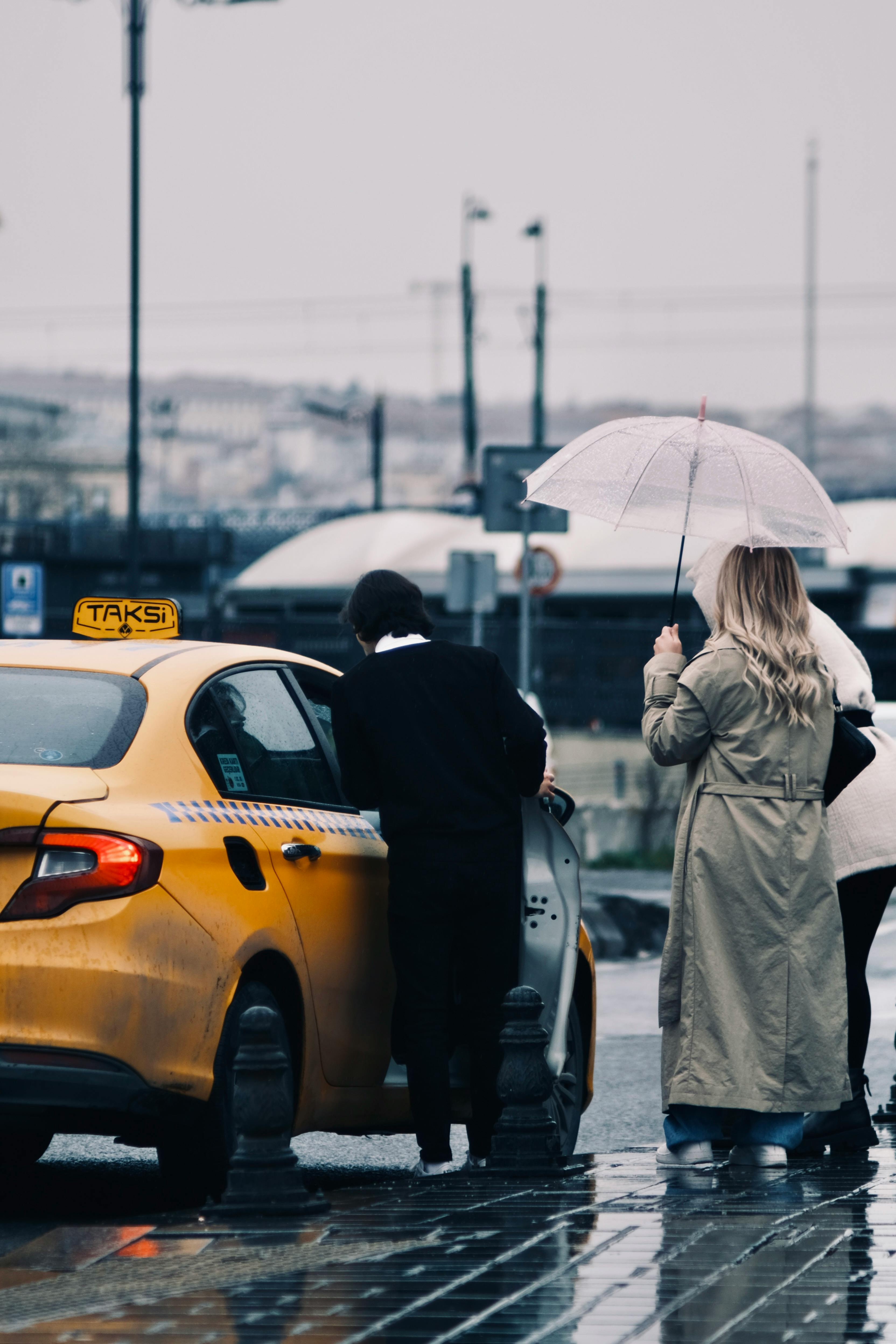 People Riding a Taxi on the Street while Raining · Free Stock Photo