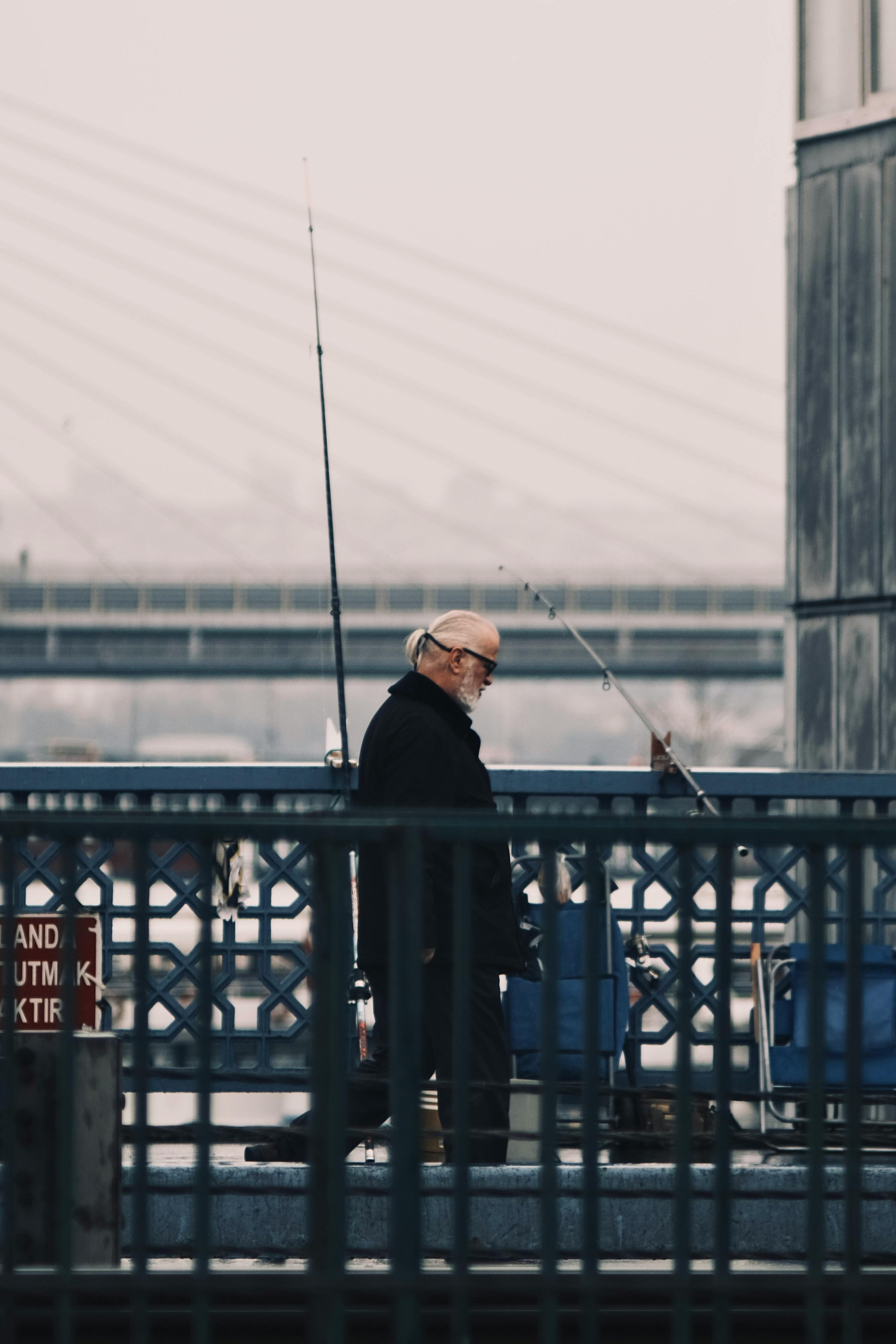 Silhouette of Man Walking near the Railings · Free Stock Photo