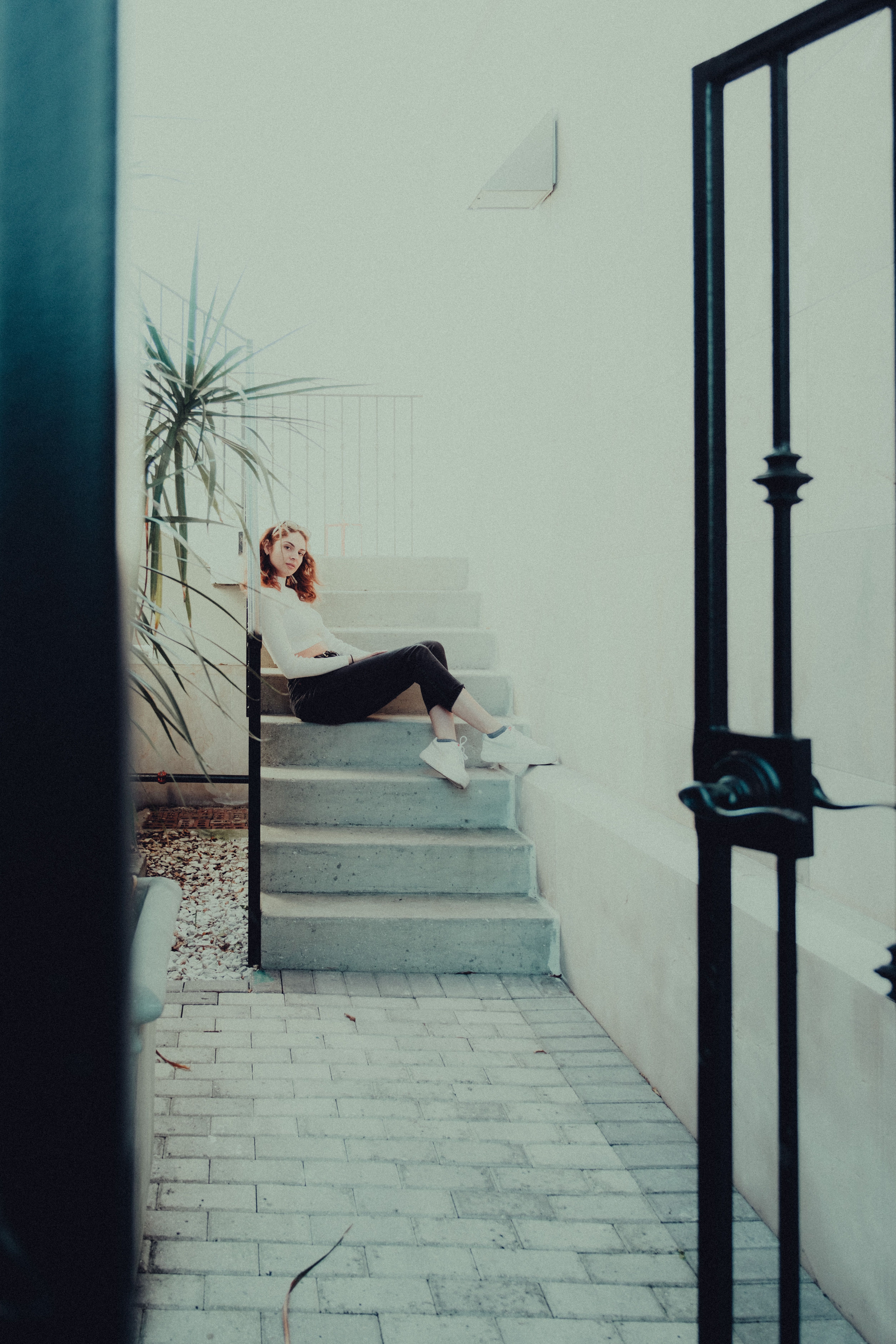 Woman Sitting on Steps in front of a Building · Free Stock Photo