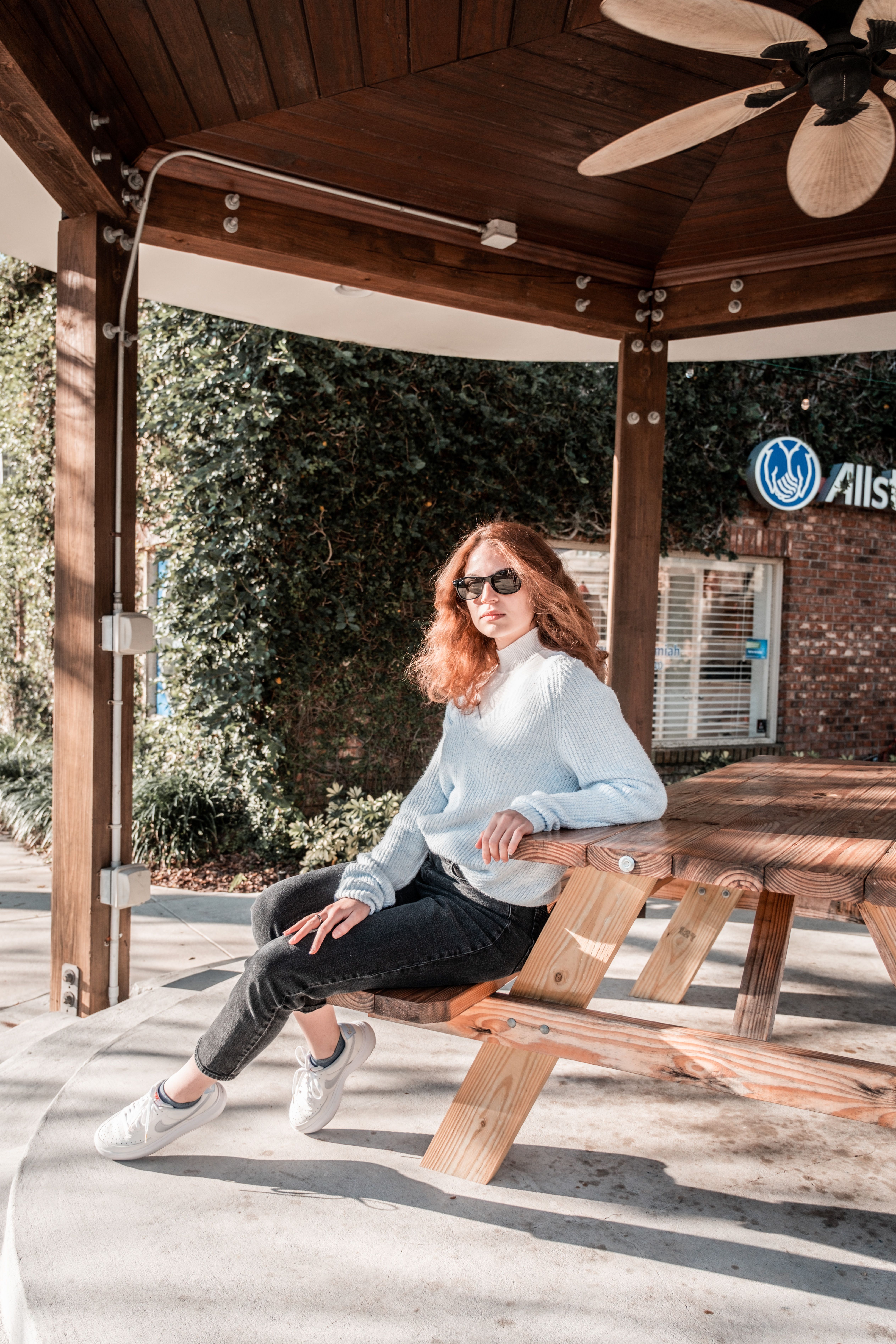 Woman Sitting on a Picnic Table · Free Stock Photo