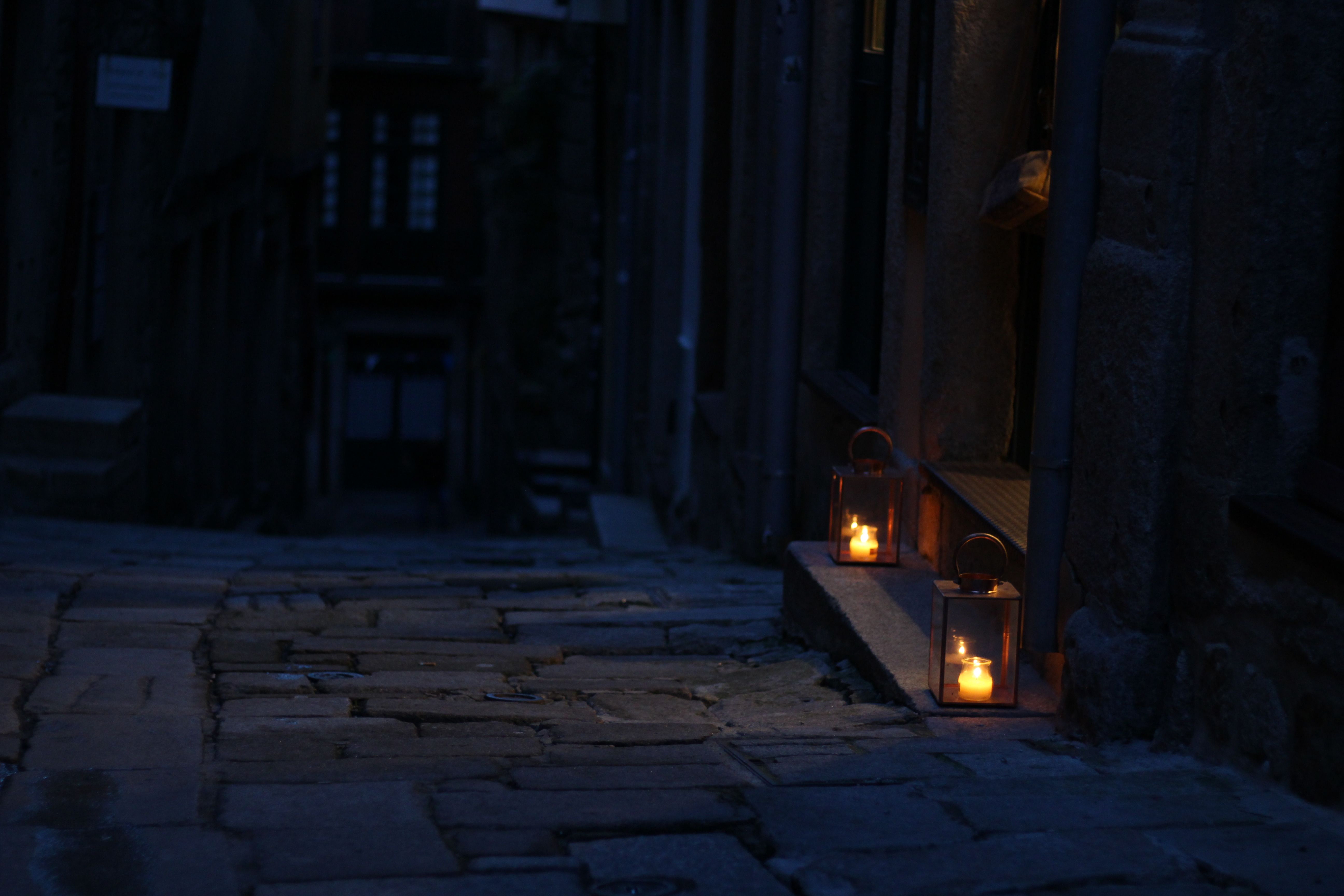 Lanterns with Wax Candles on Pavement near Building Wall at Night ...