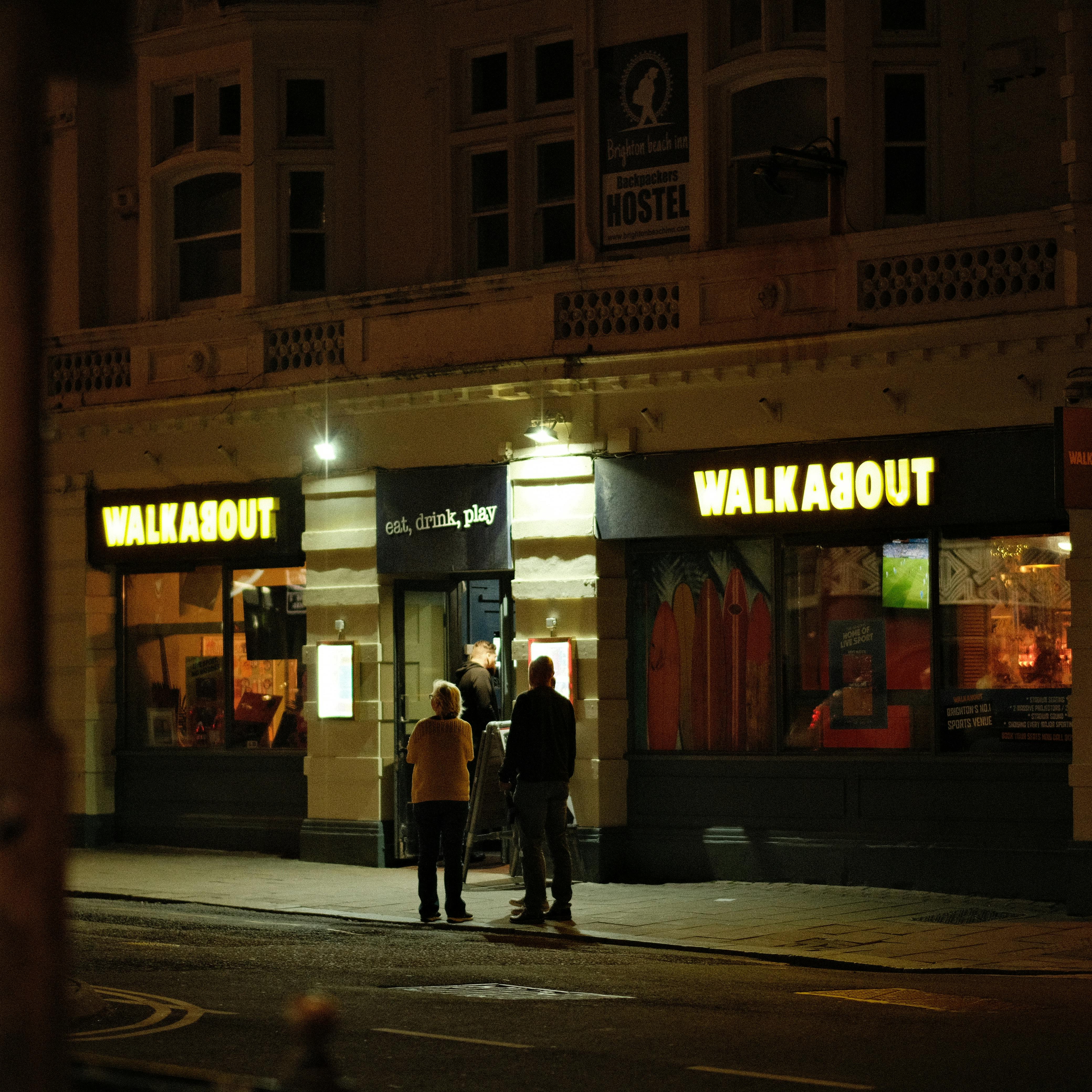 Elderly Couple in Front of the Walkabout Bar · Free Stock Photo