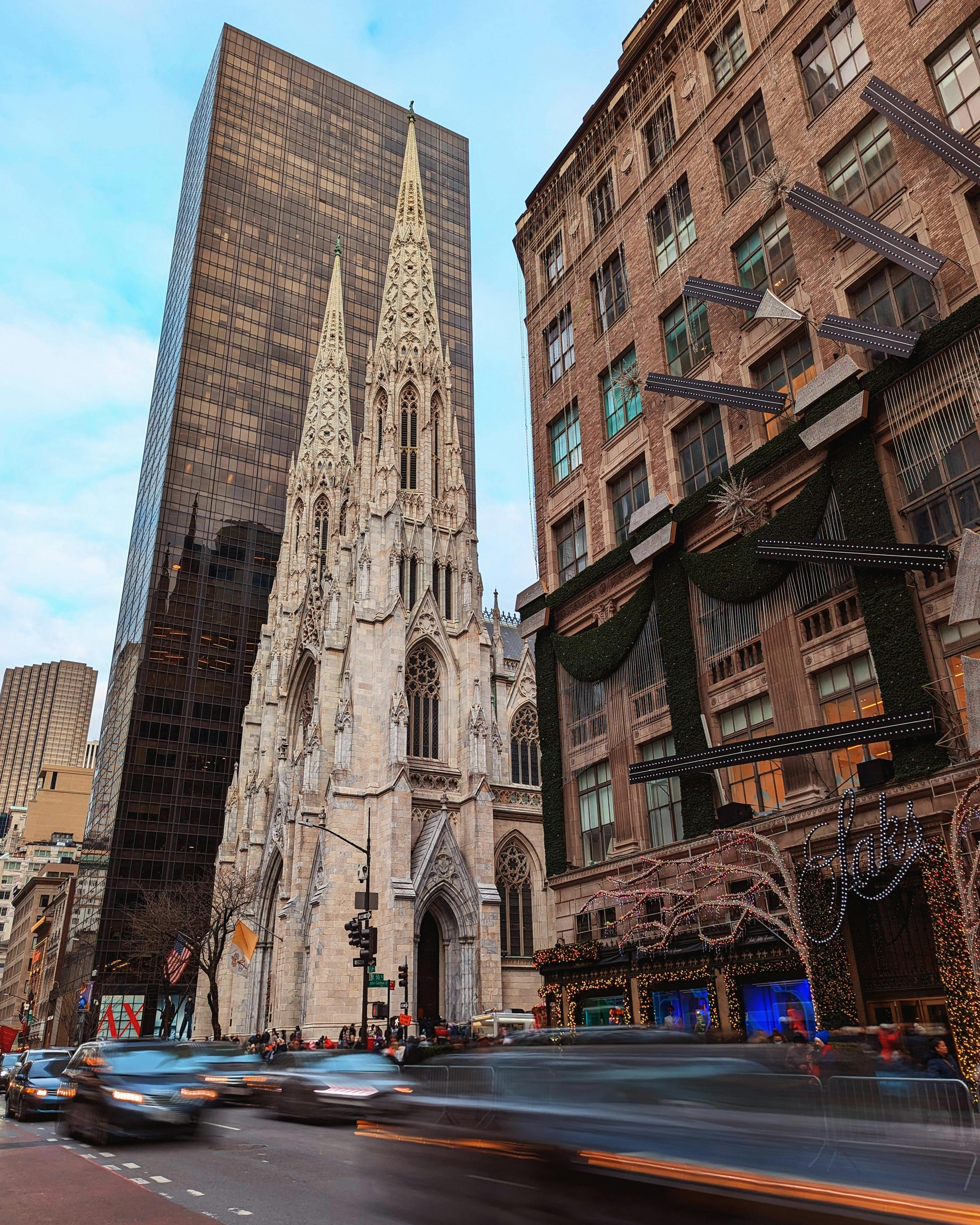 Cathedral Towering over Traffic on Street · Free Stock Photo