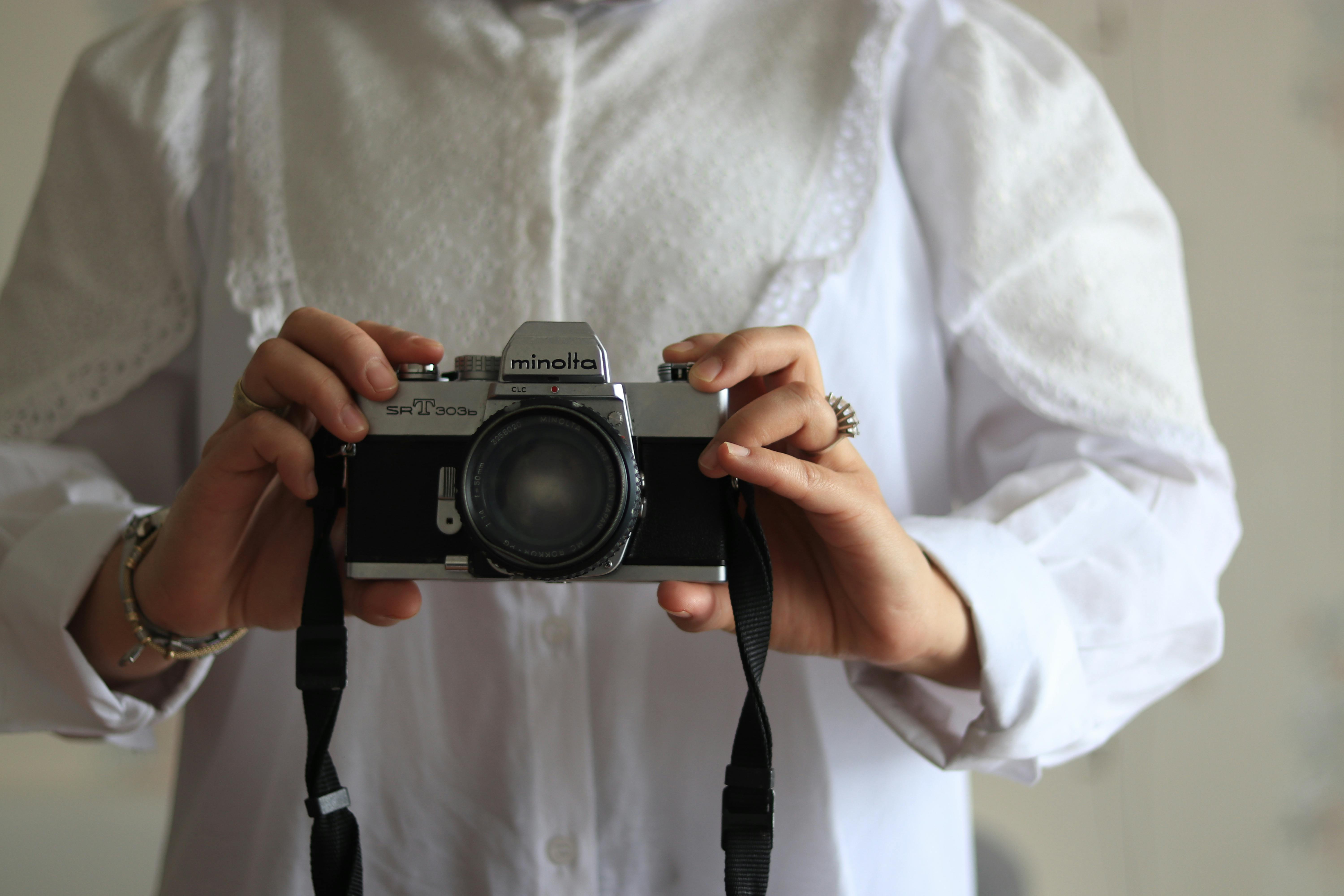 Person in White Dress Shirt Holding a Camera · Free Stock Photo