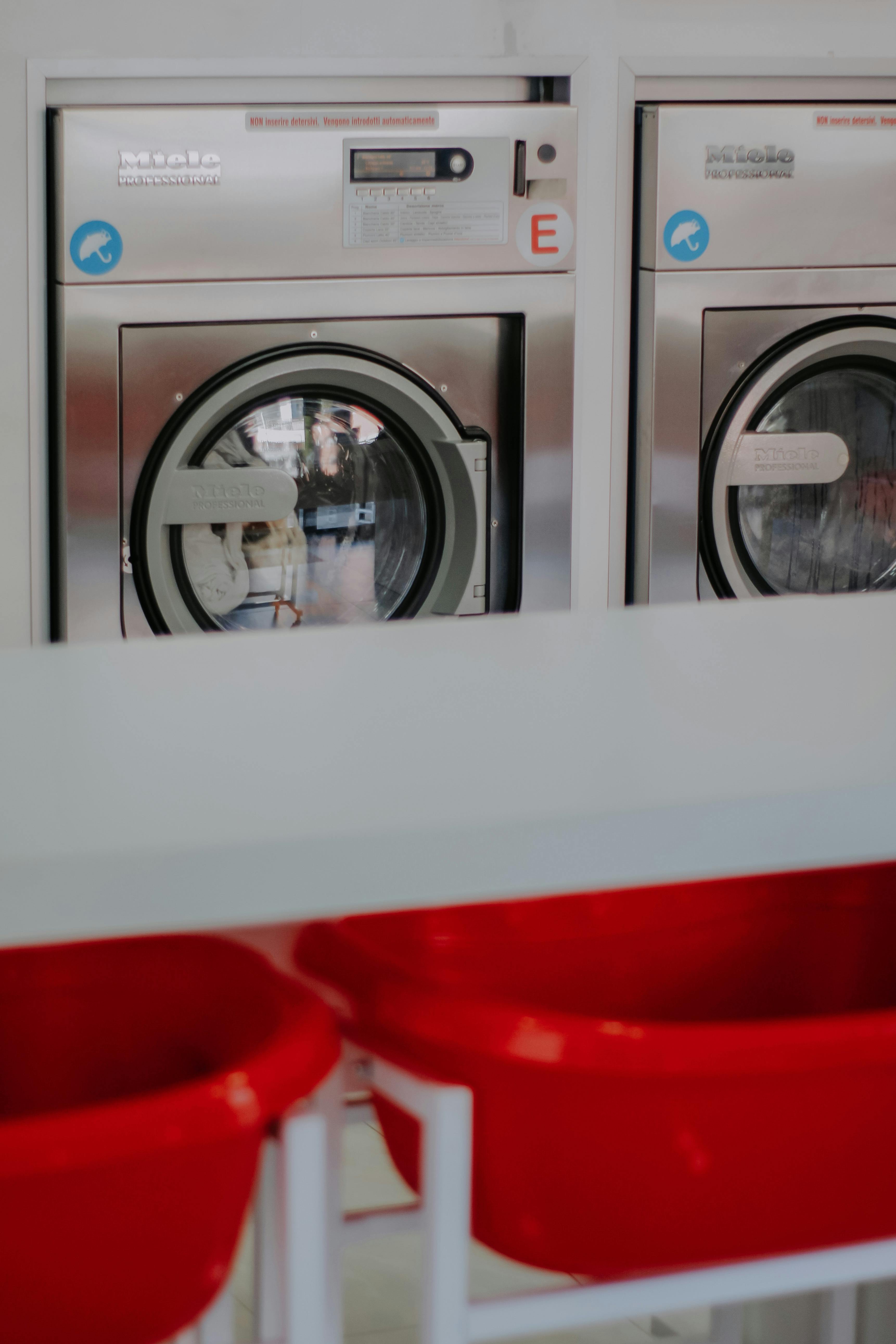 Woman Sticking Her Face to a Washing Machine Window · Free Stock Photo