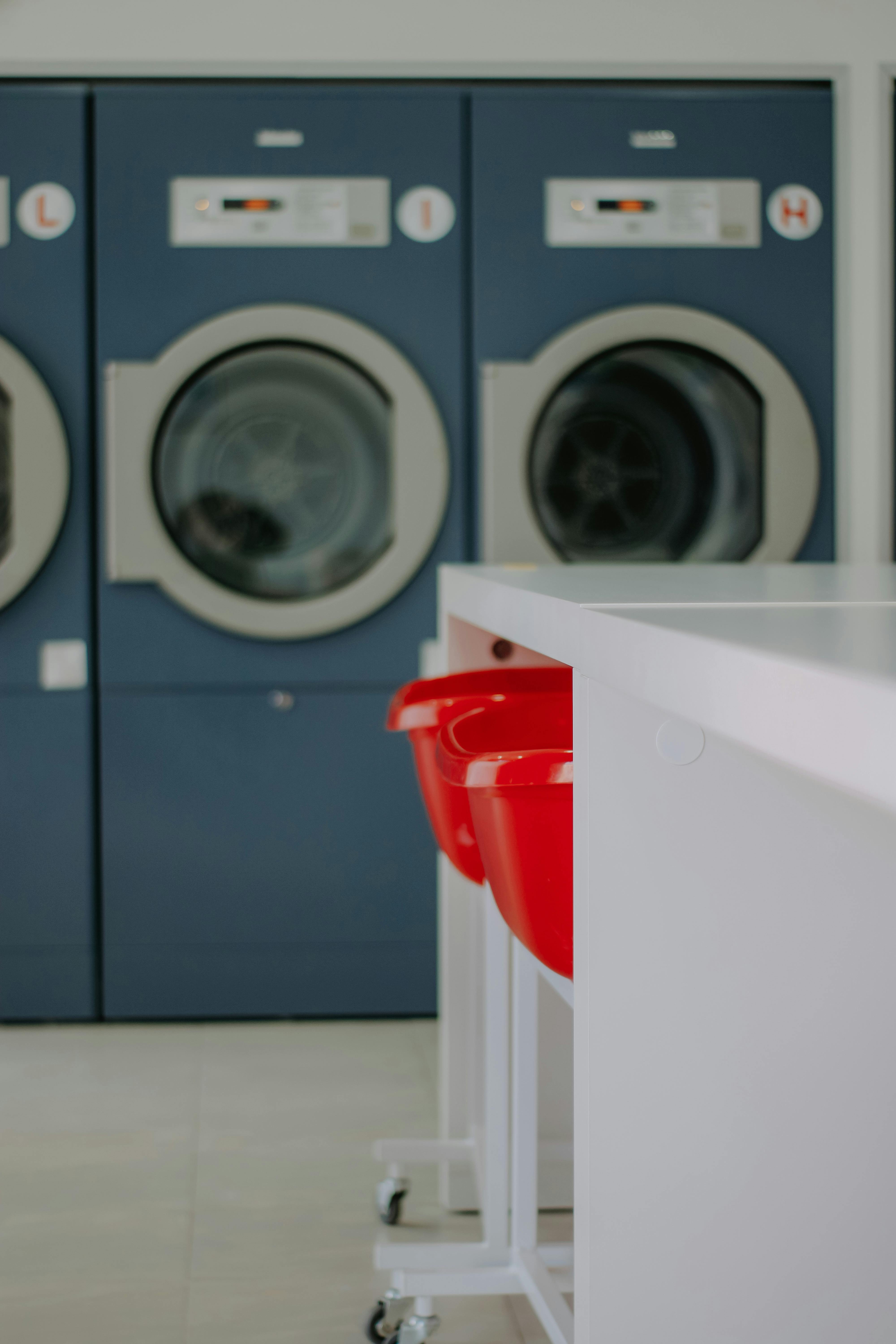 Woman Sticking Her Face to a Washing Machine Window · Free Stock Photo