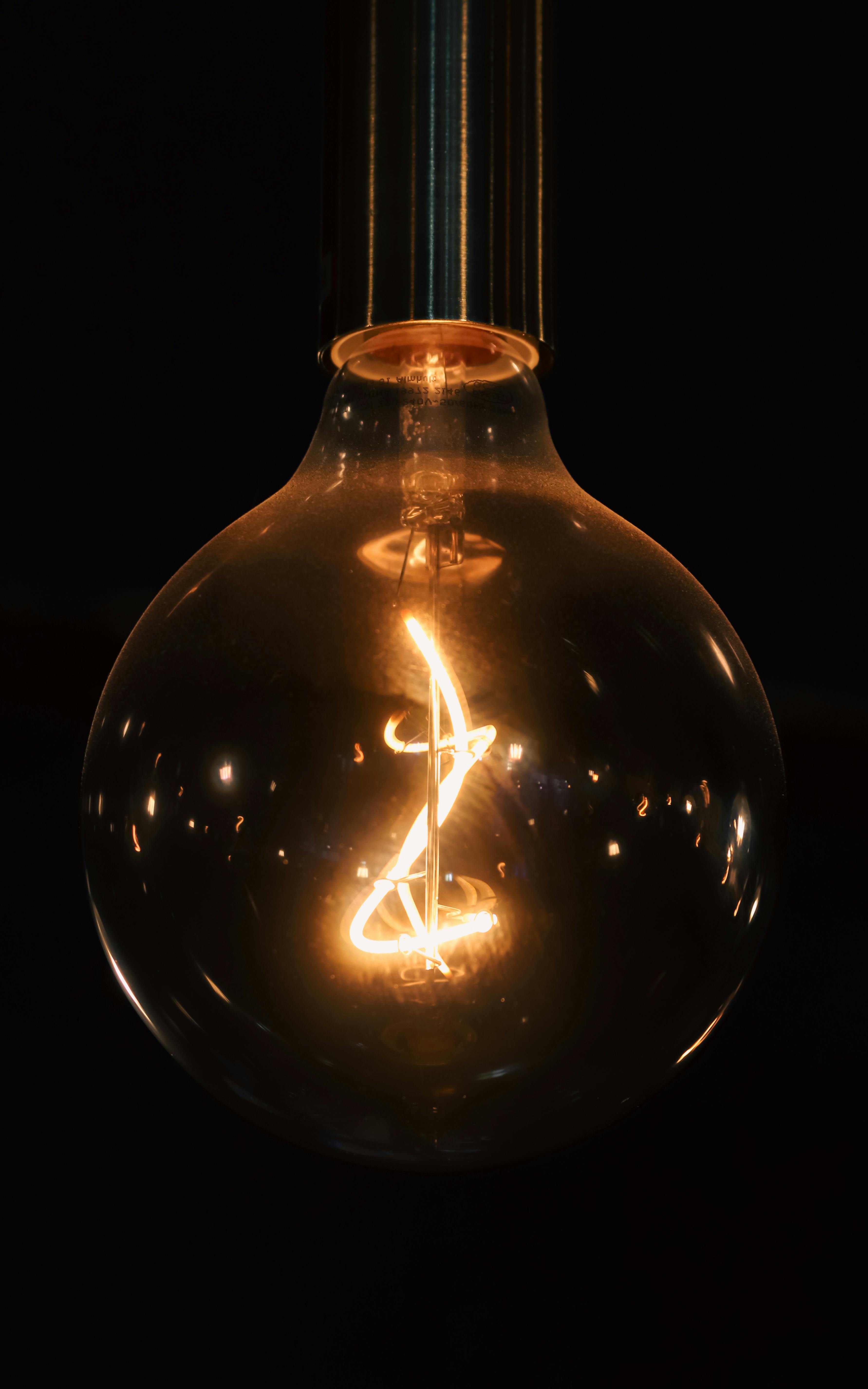 Woman About To Hold A Pendant Lamp · Free Stock Photo