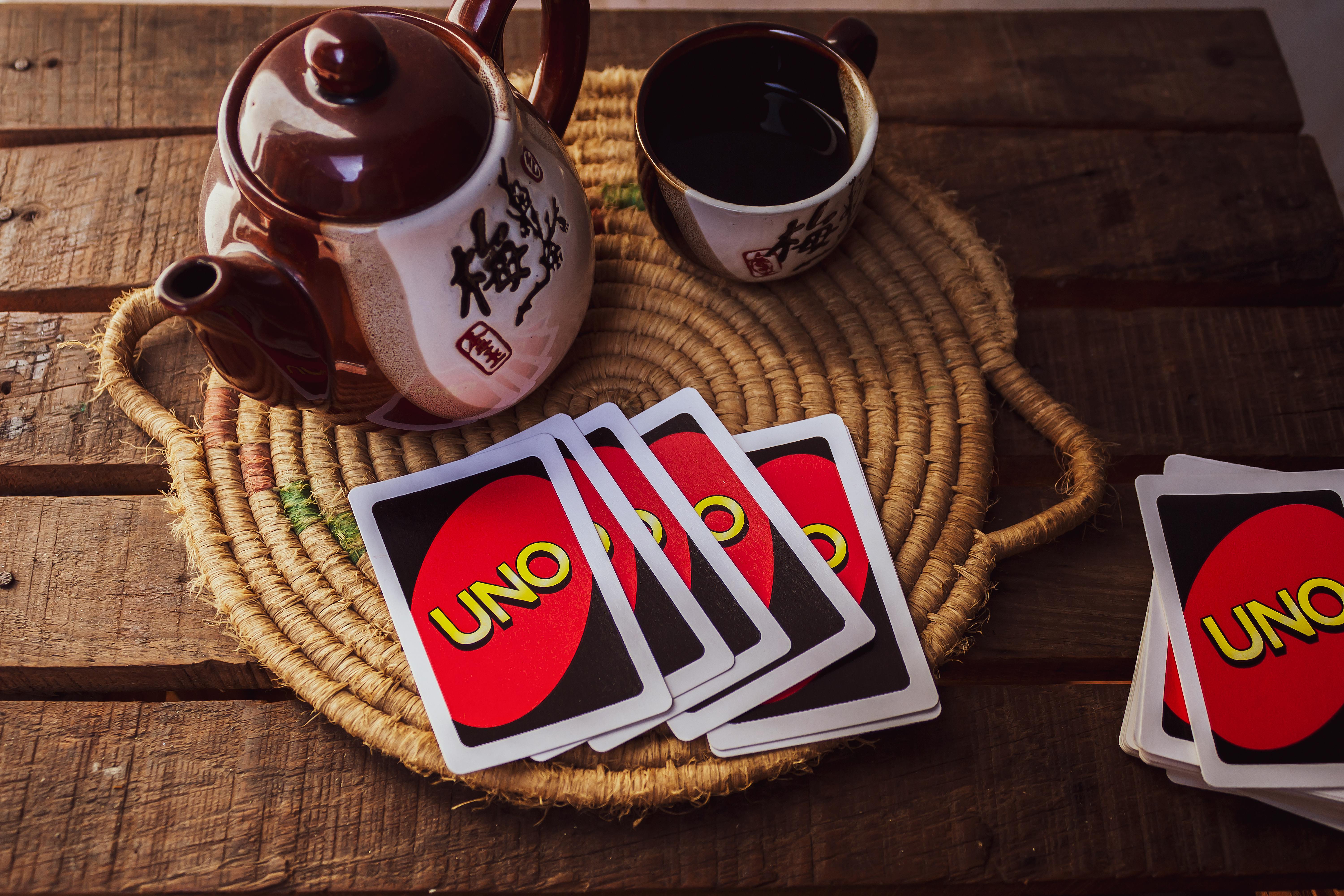 Uno Cards and Teapot on Wooden Table · Free Stock Photo