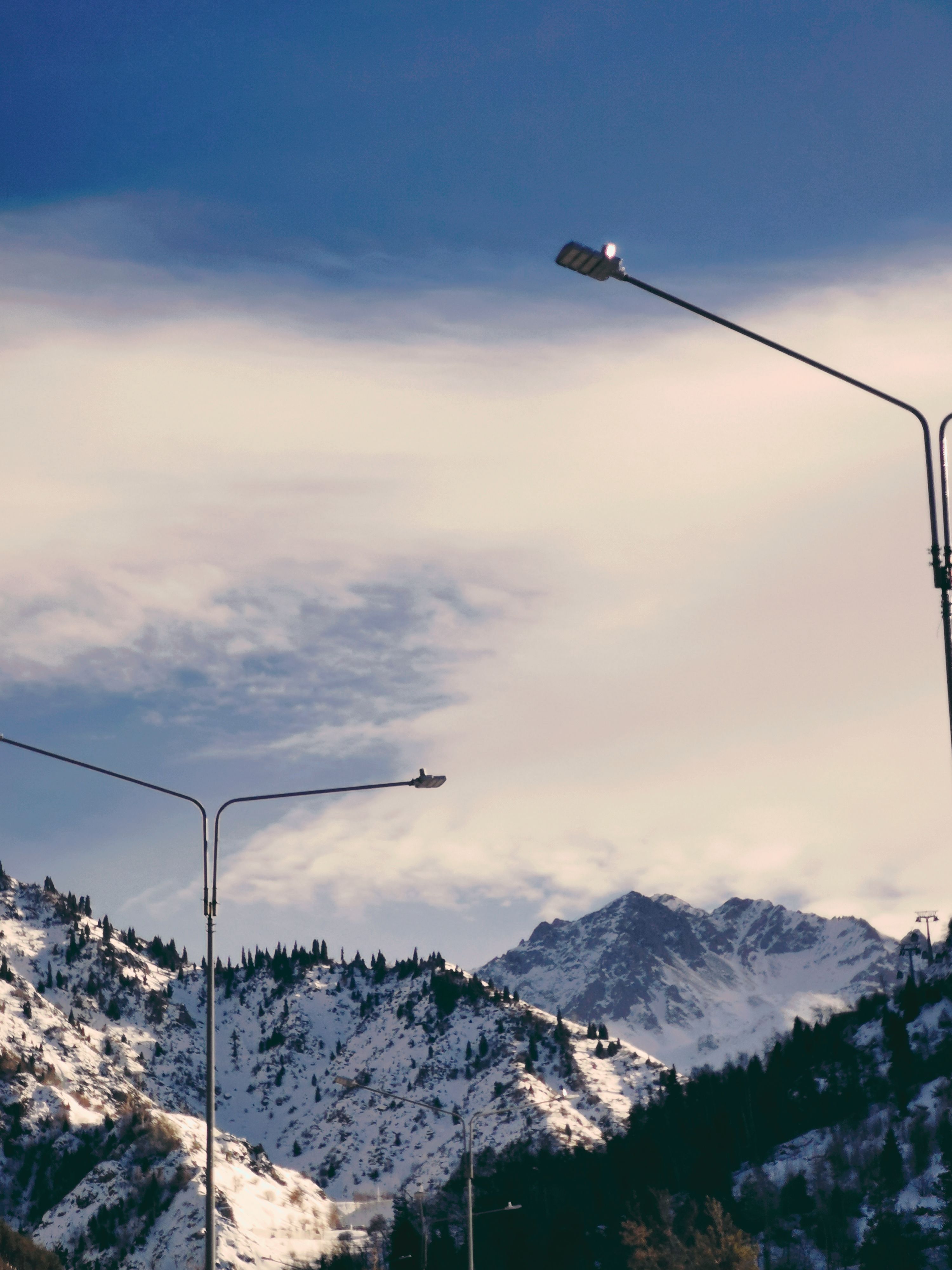 Lamp Posts Near the Snow Covered Mountains · Free Stock Photo