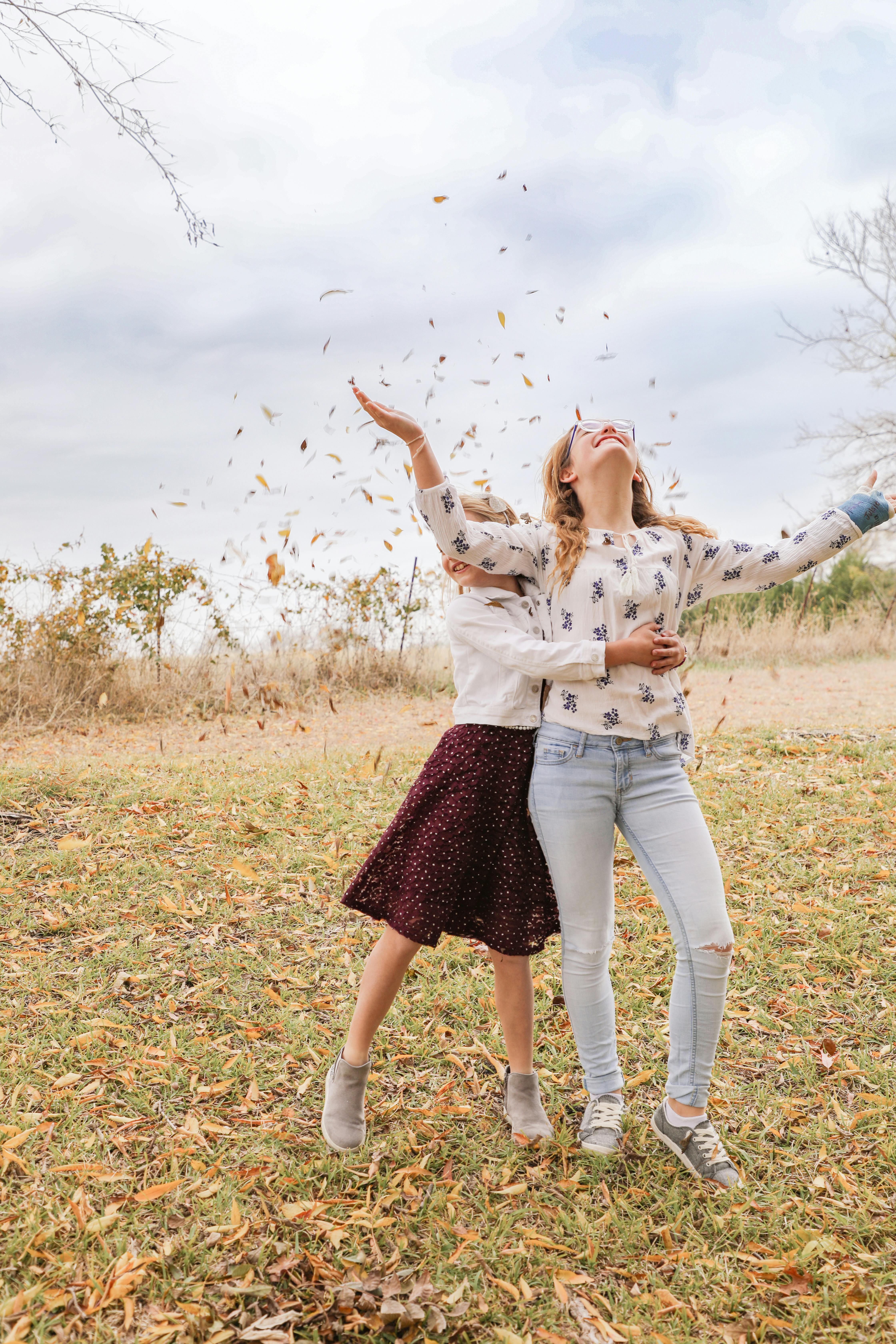 Cheerful Girls Throwing Confetti · Free Stock Photo