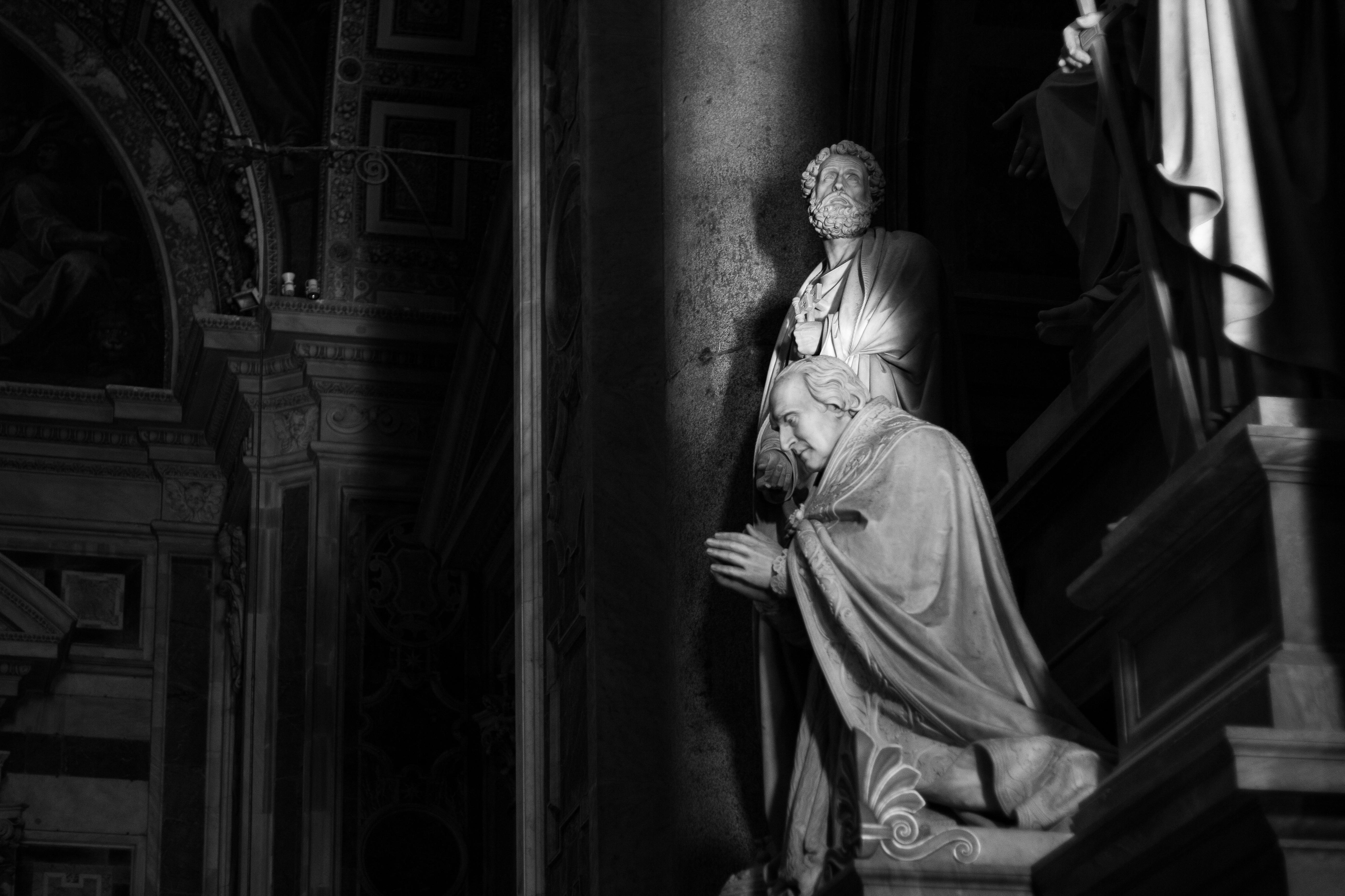Praying Woman Touching Statue with Forehead · Free Stock Photo