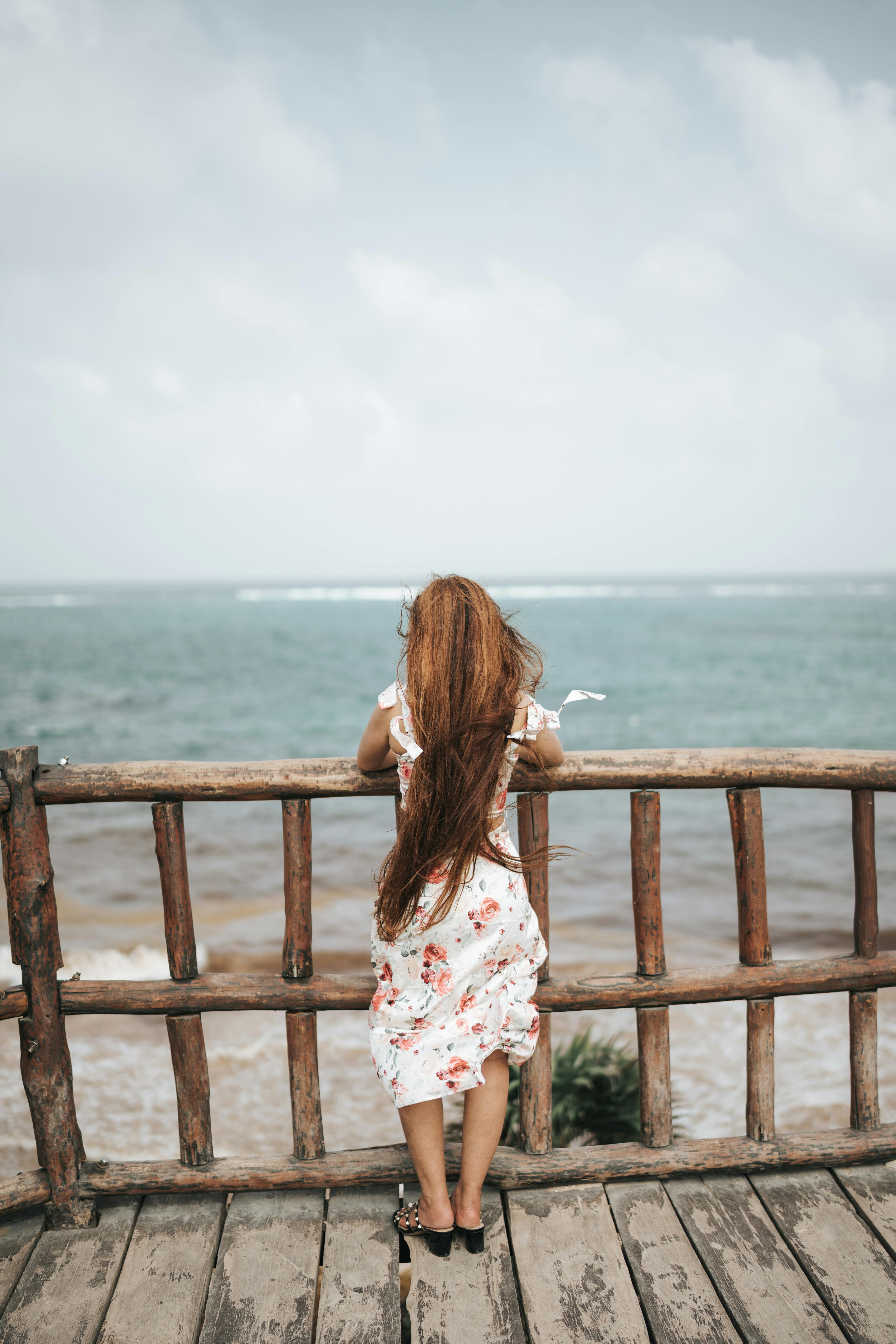 Woman in Bikini Standing by Railing · Free Stock Photo