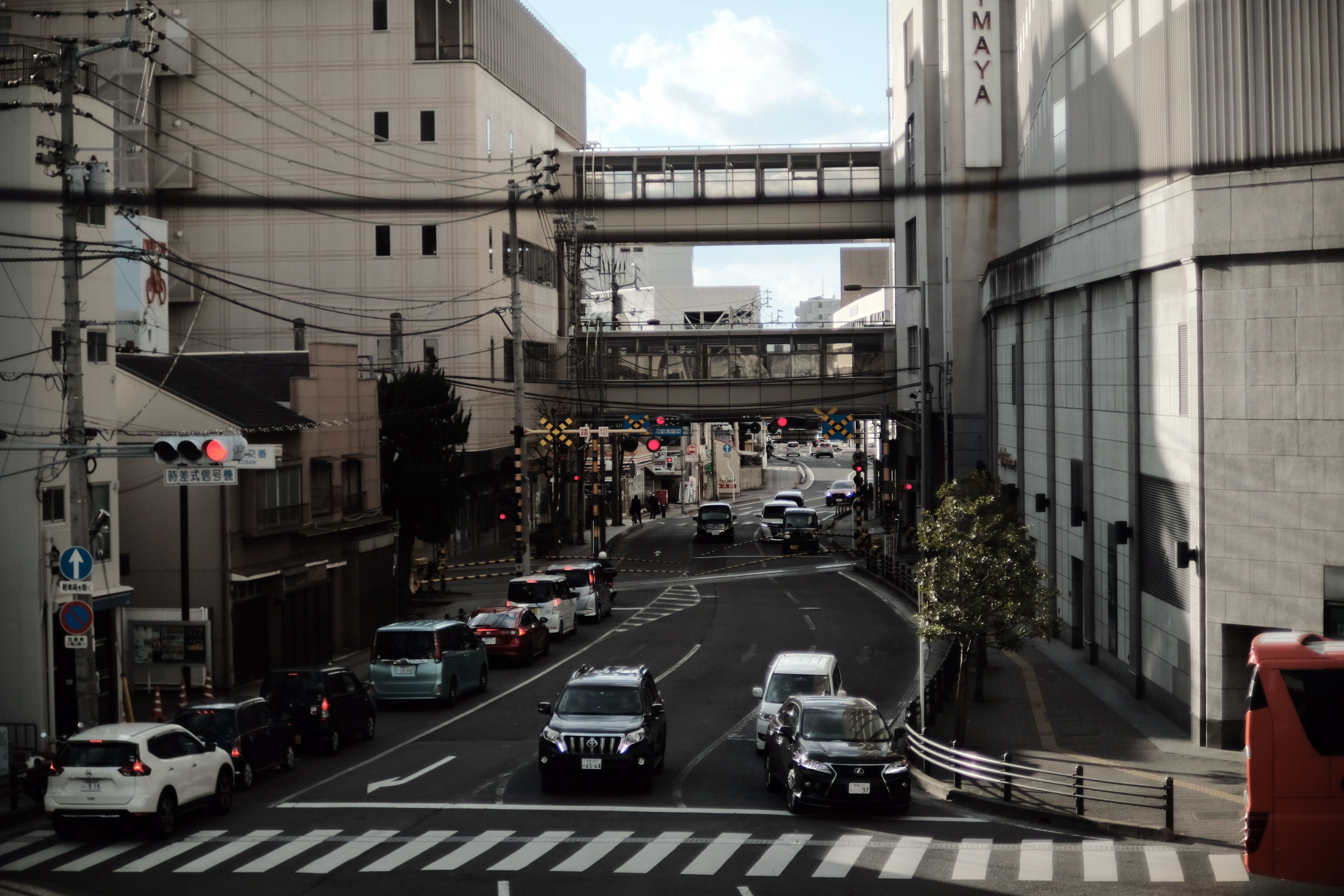 A Moving Cars on the Road Between Buildings · Free Stock Photo