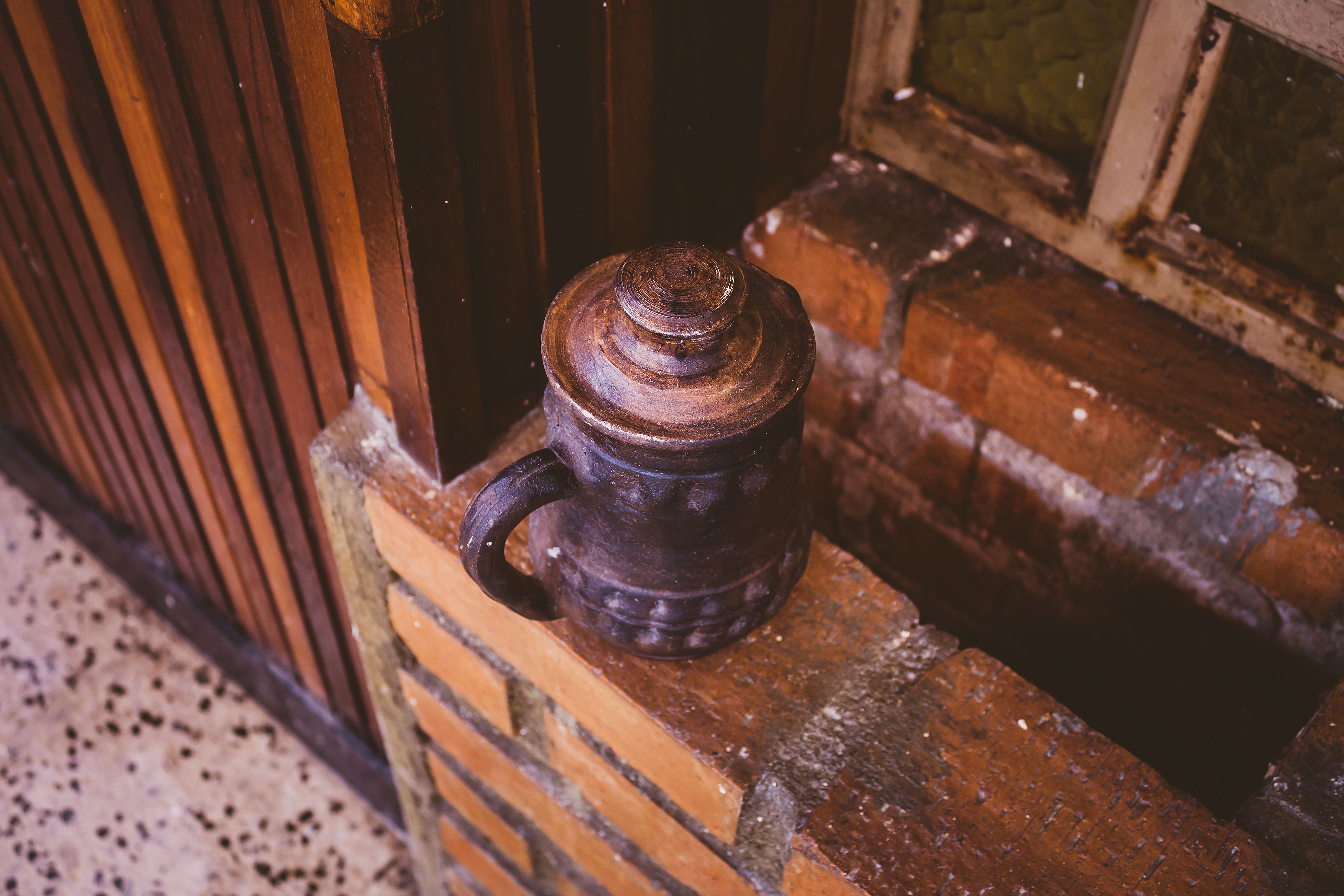 Brass Pitcher on Wall · Free Stock Photo
