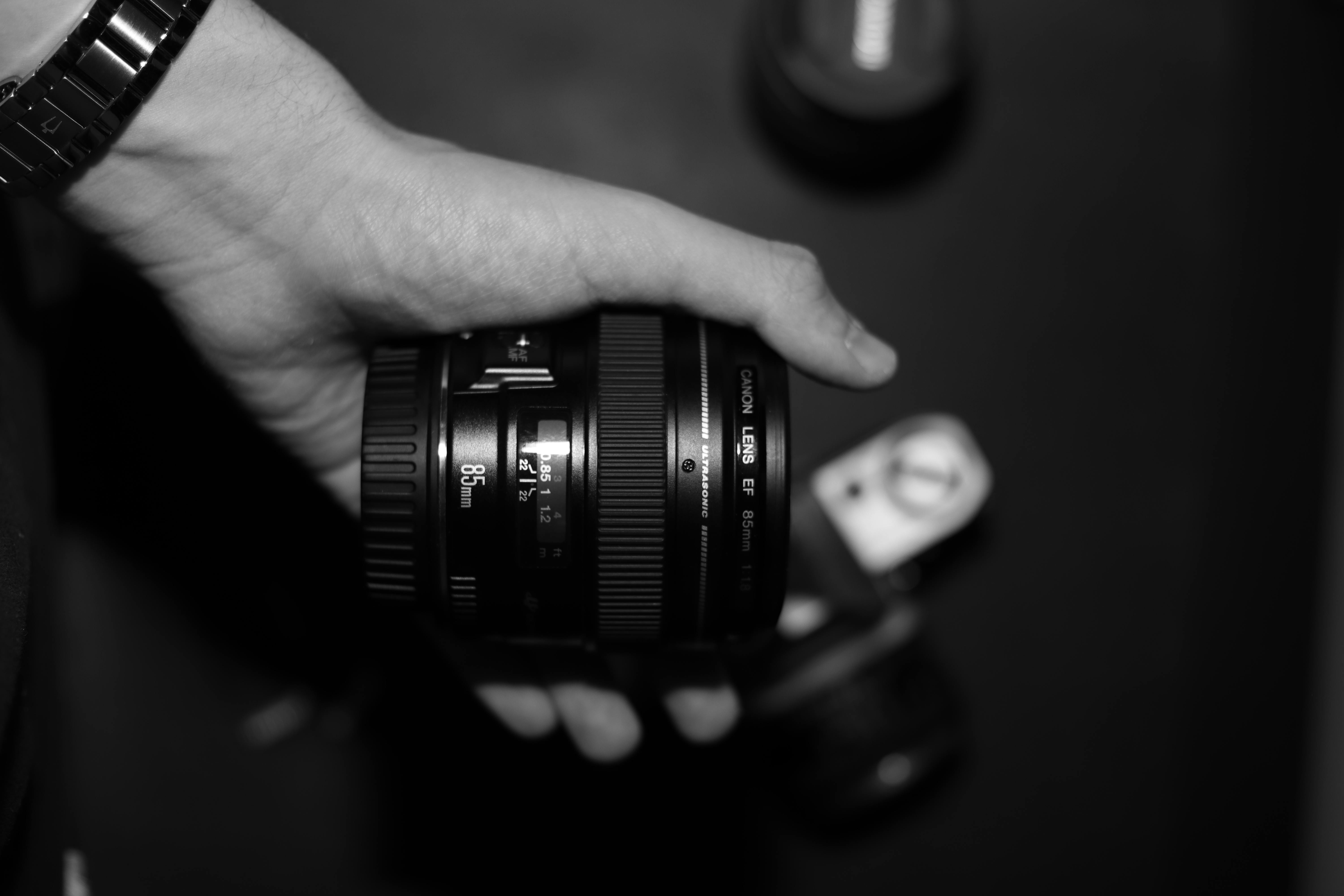 Man Hand Holding Camera Lens · Free Stock Photo