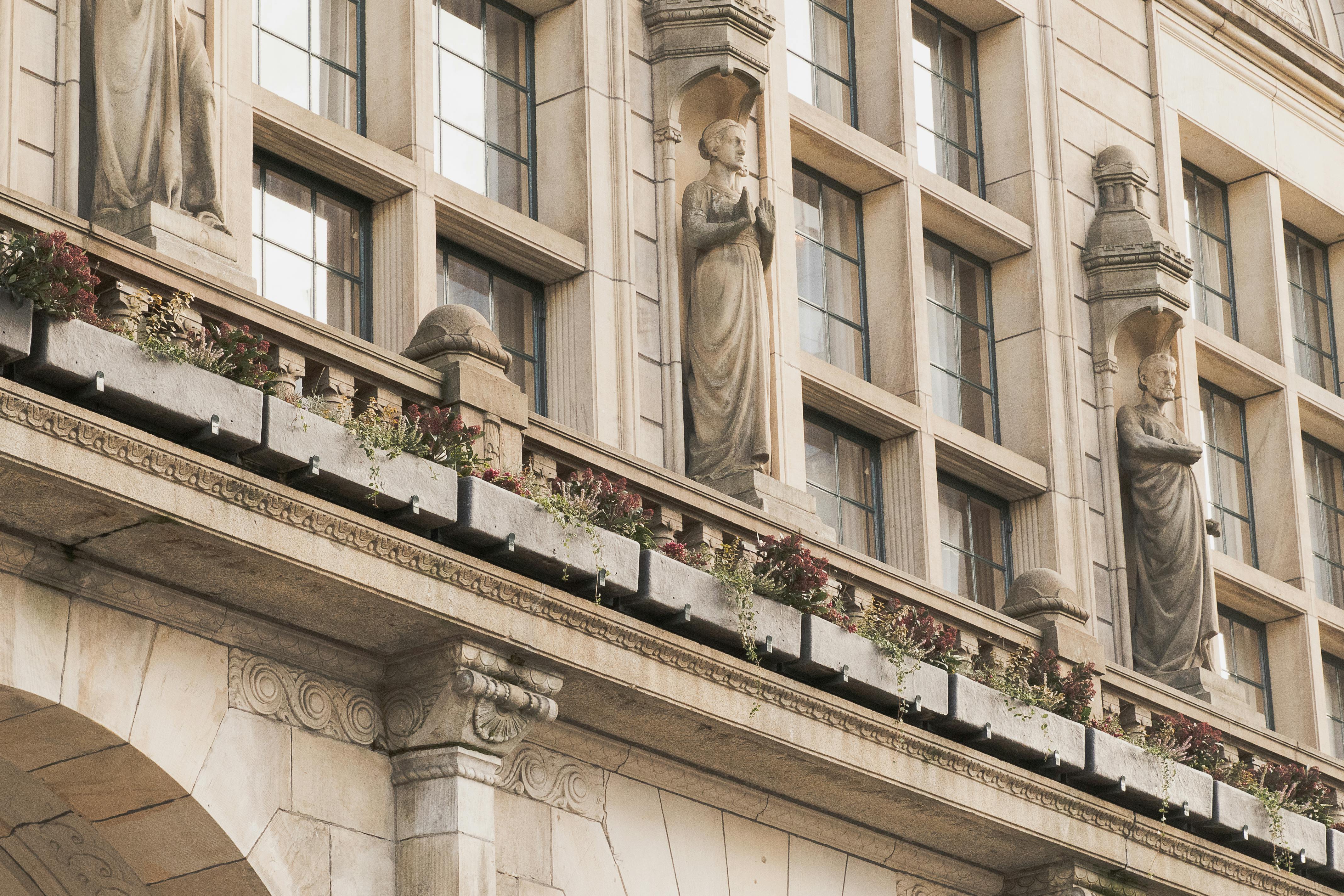 Sculptures on Building Wall · Free Stock Photo