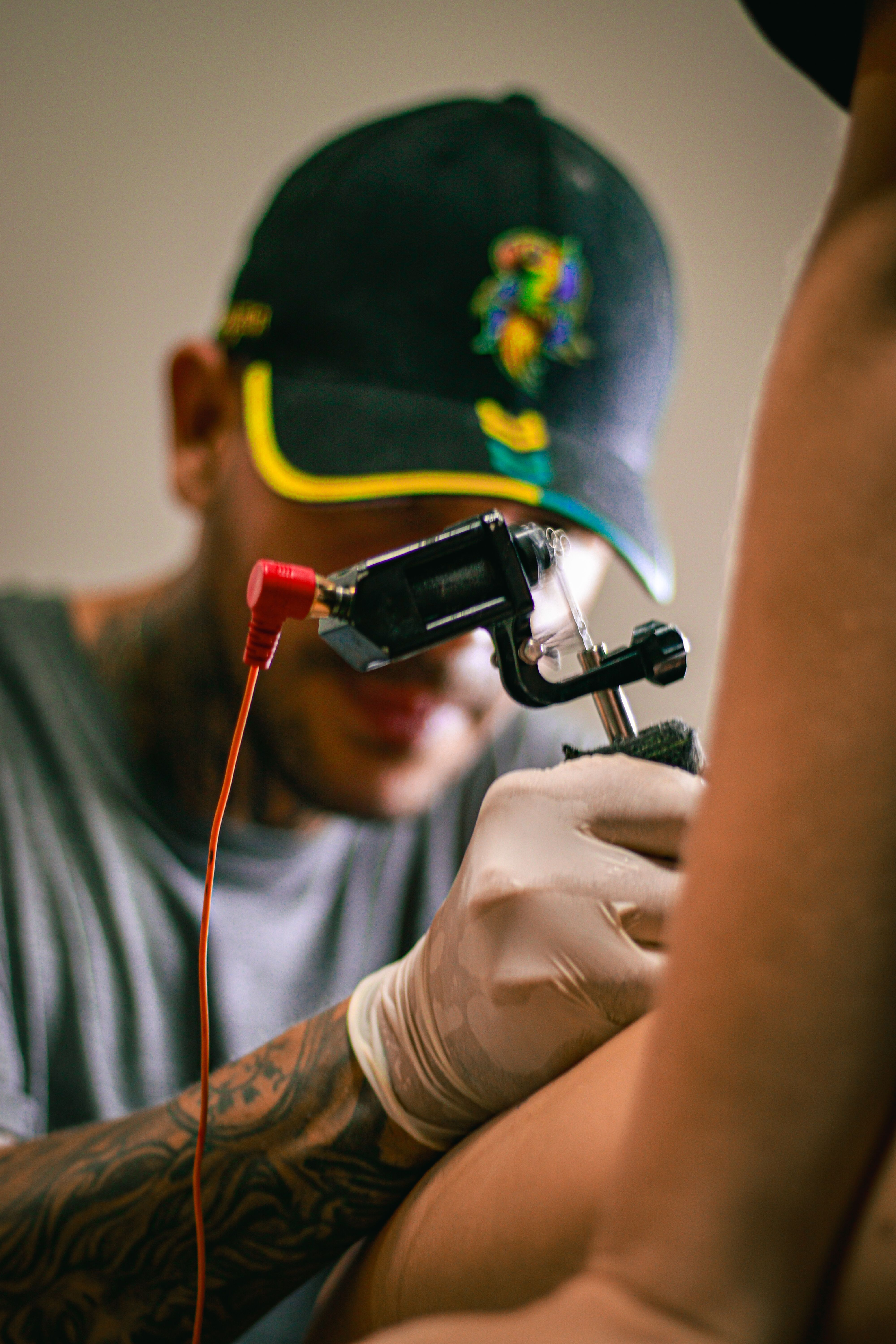 A Tattoo Artist Tattooing a Client · Free Stock Photo