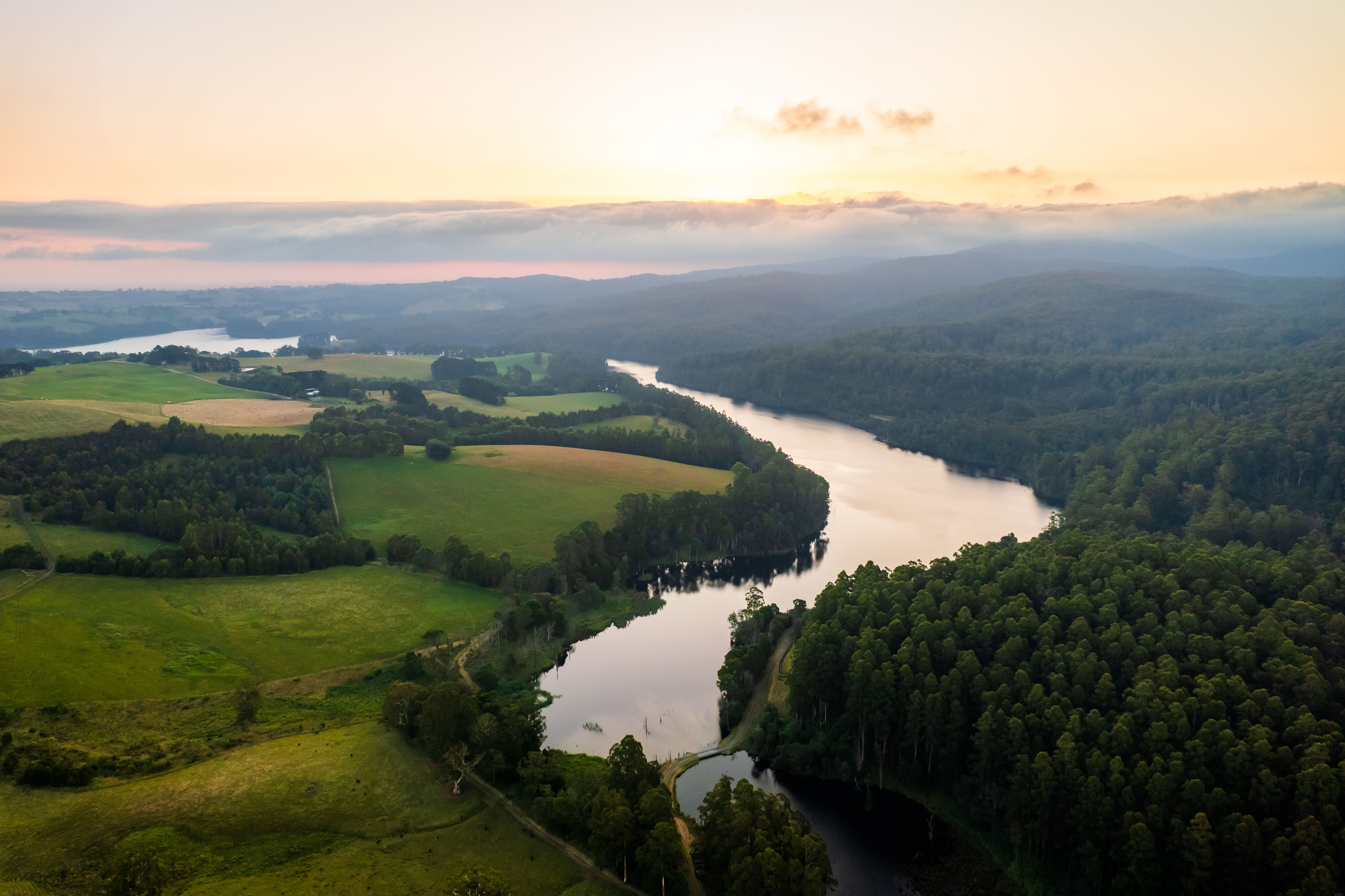 Aerial View of the River Between Fields and Forest at Sunset · Free ...