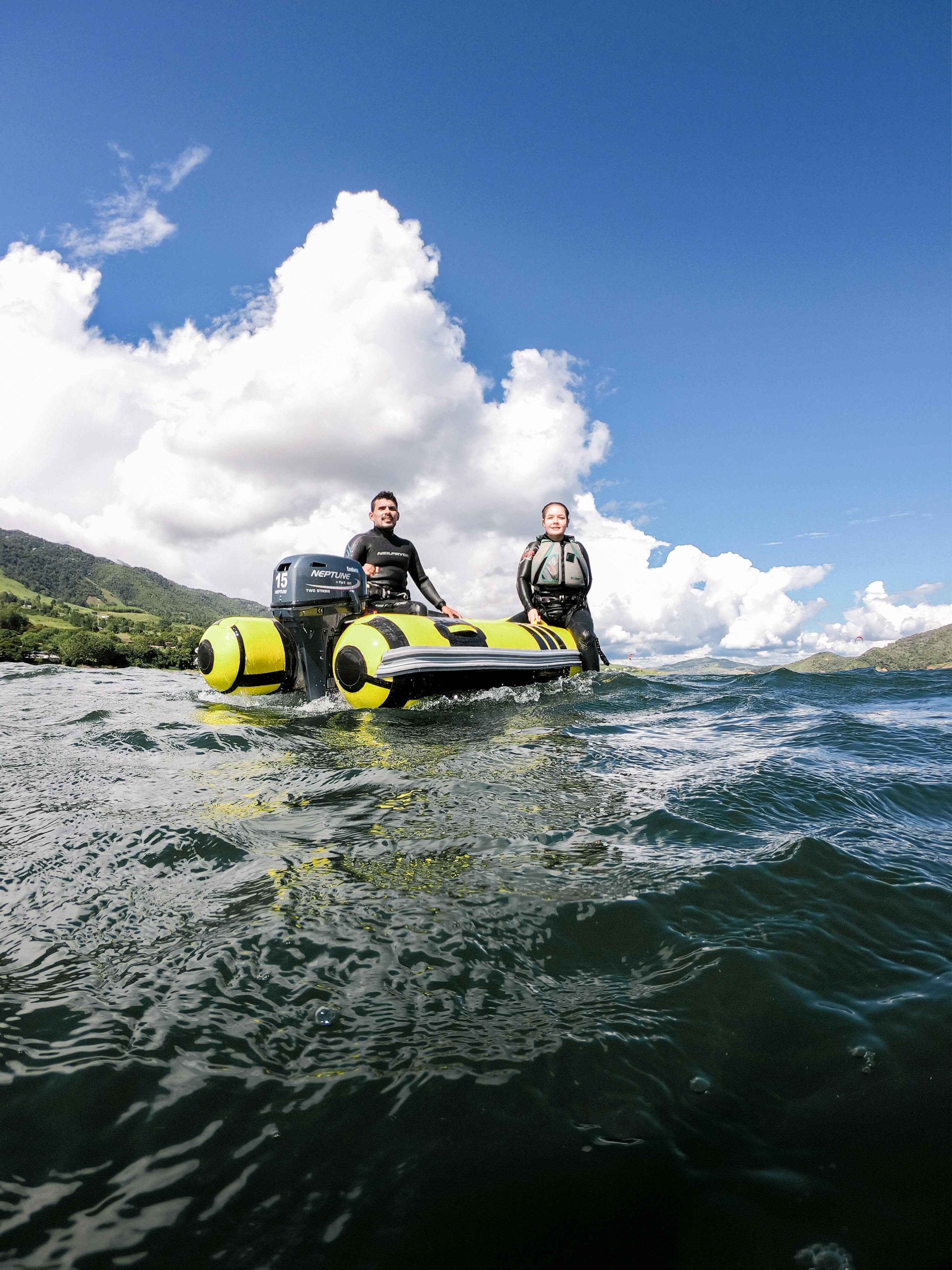 Man and Woman Riding Yellow Motorboat · Free Stock Photo