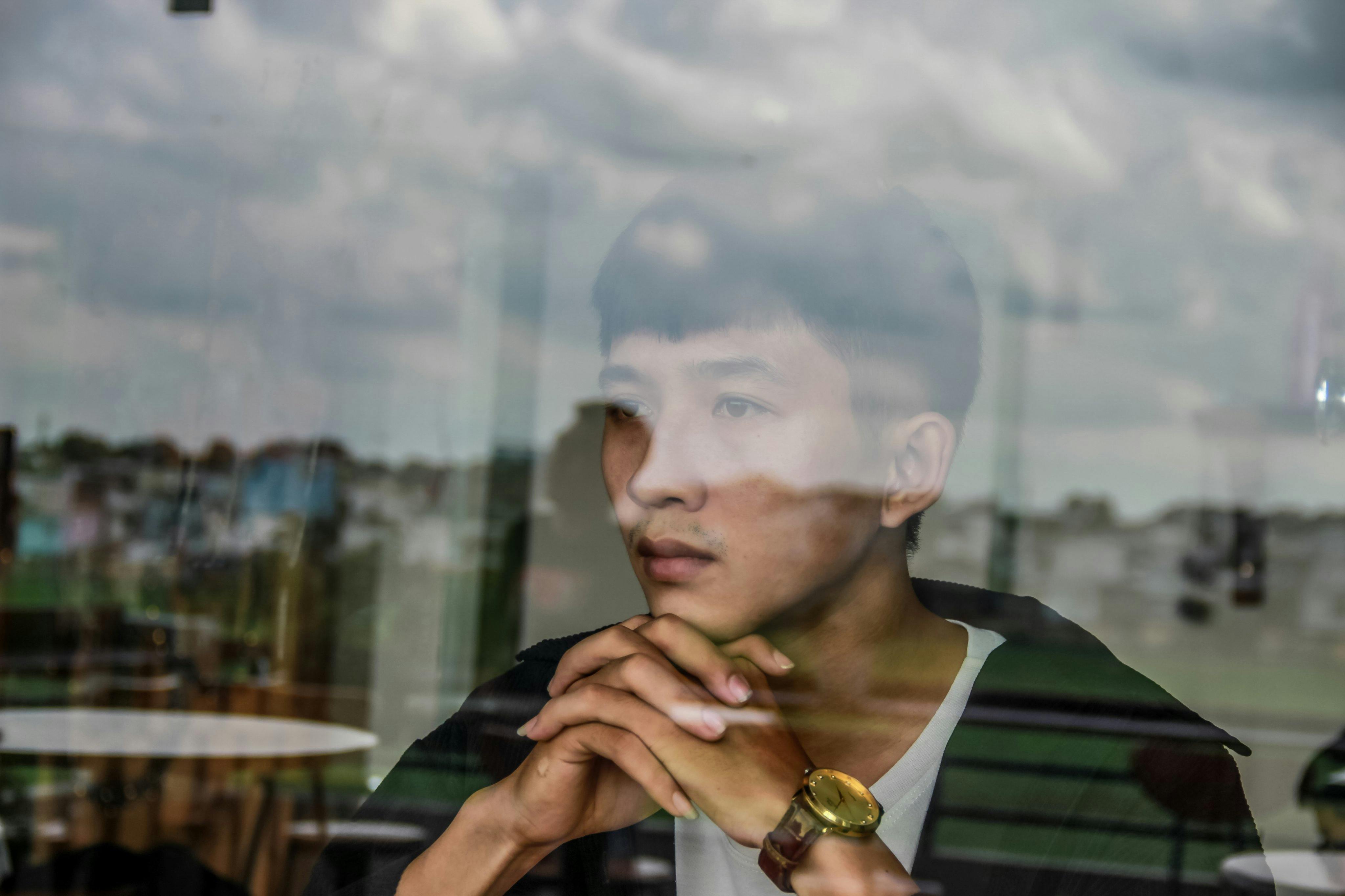 Pensive Man Seen through Window Pane · Free Stock Photo