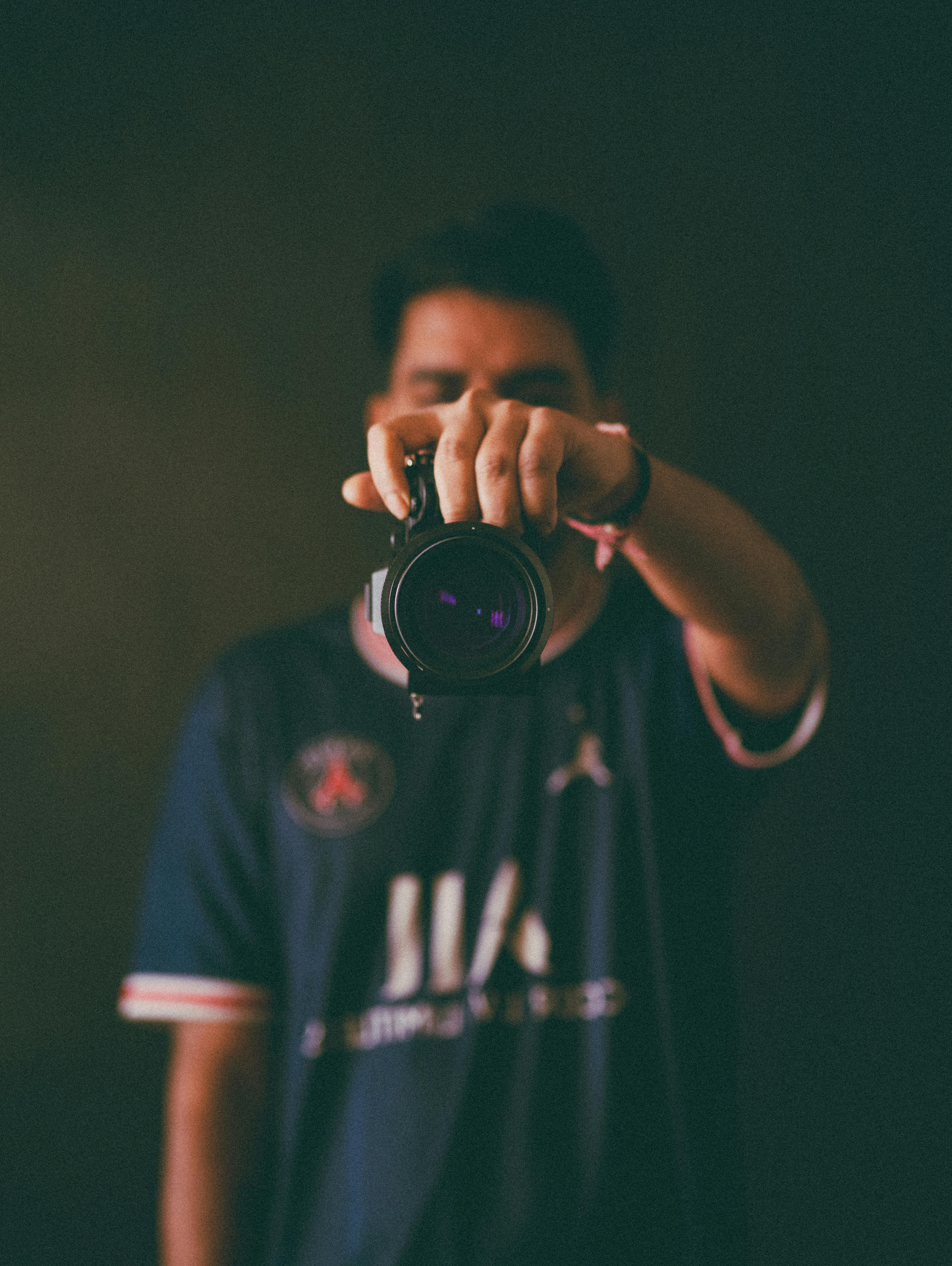 Photography of Man Holding Dslr Camera · Free Stock Photo