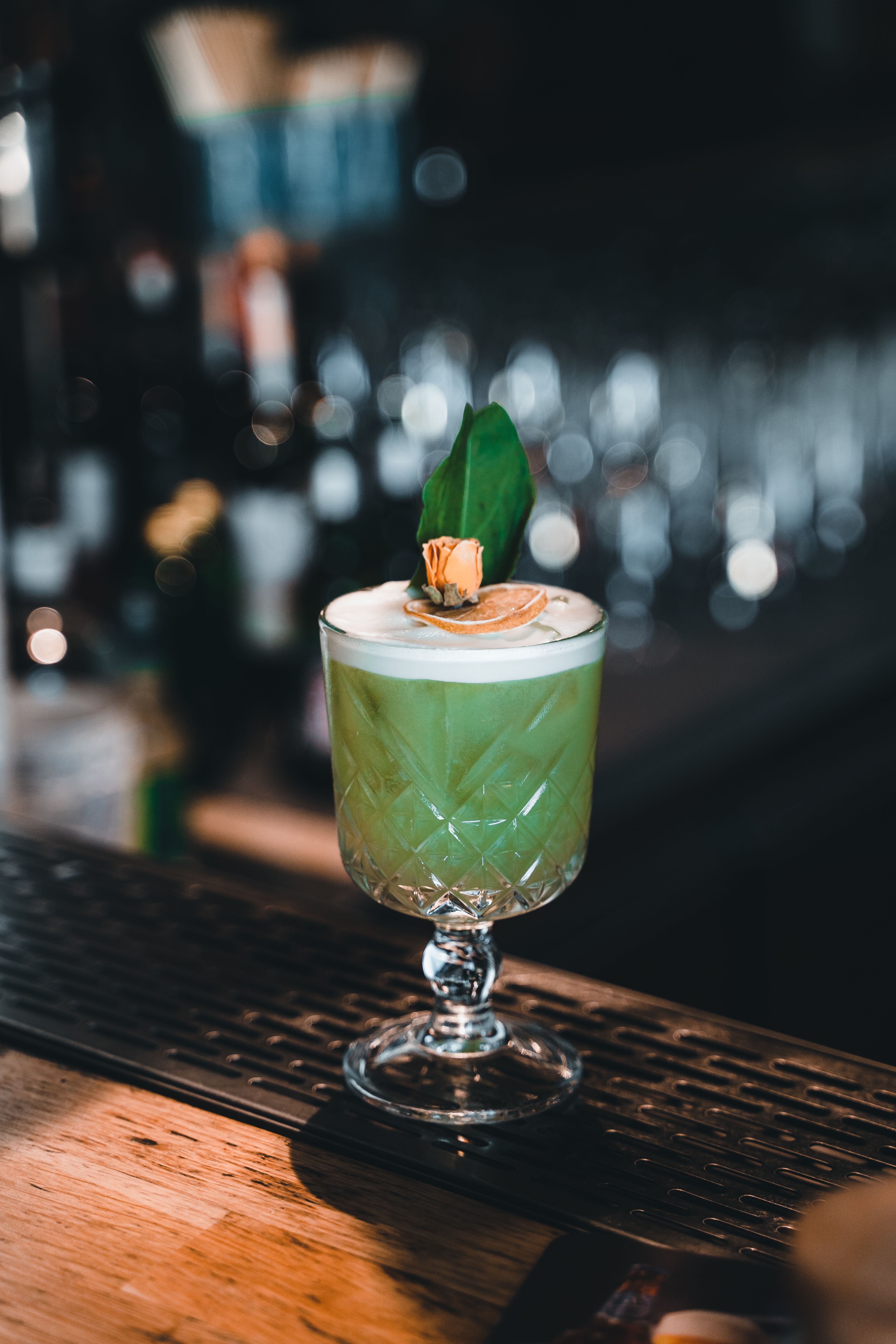 Elegant Green Cocktail on Bar Counter · Free Stock Photo