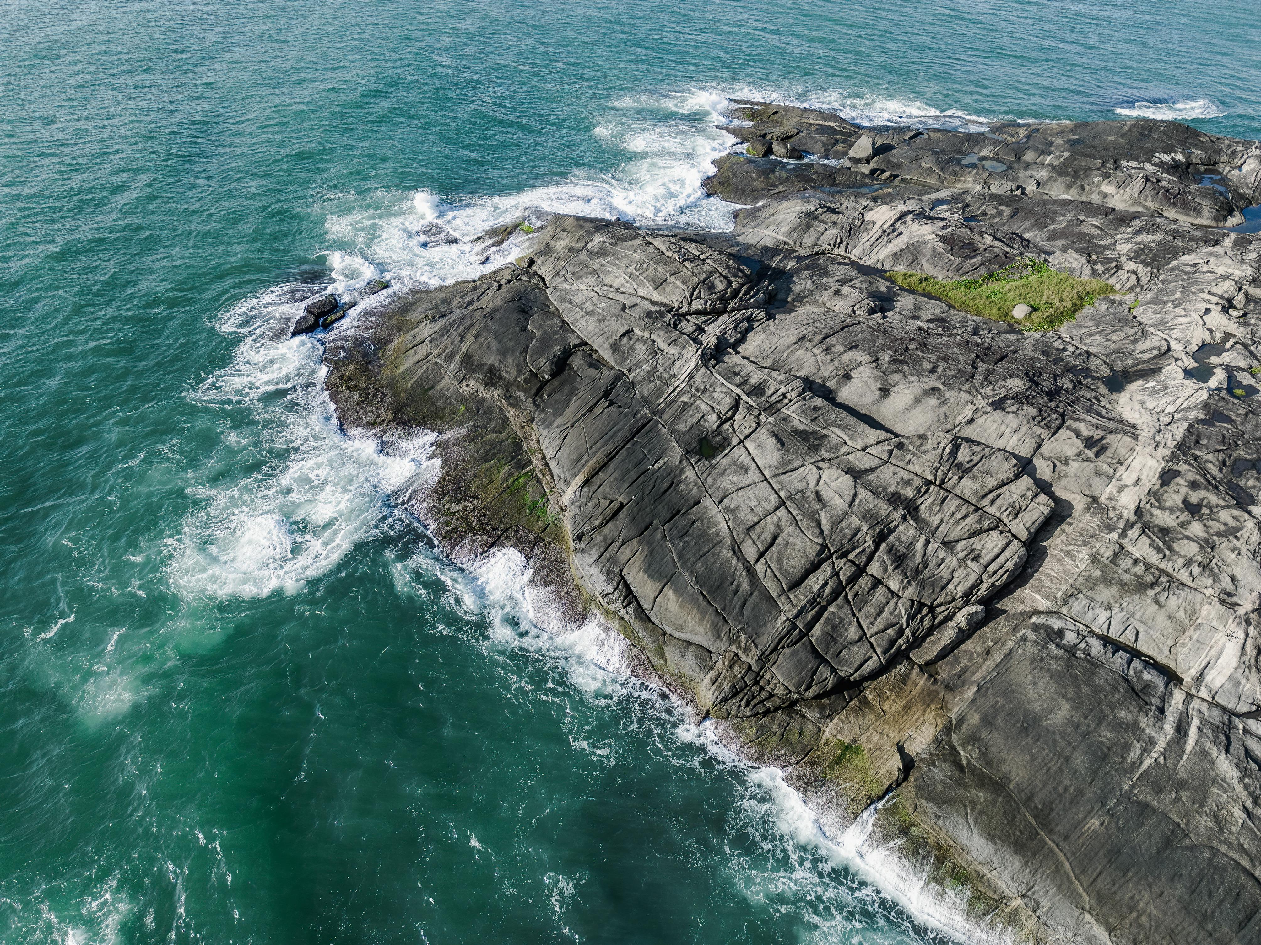 Aerial Photography of Seashore Beside Islet · Free Stock Photo