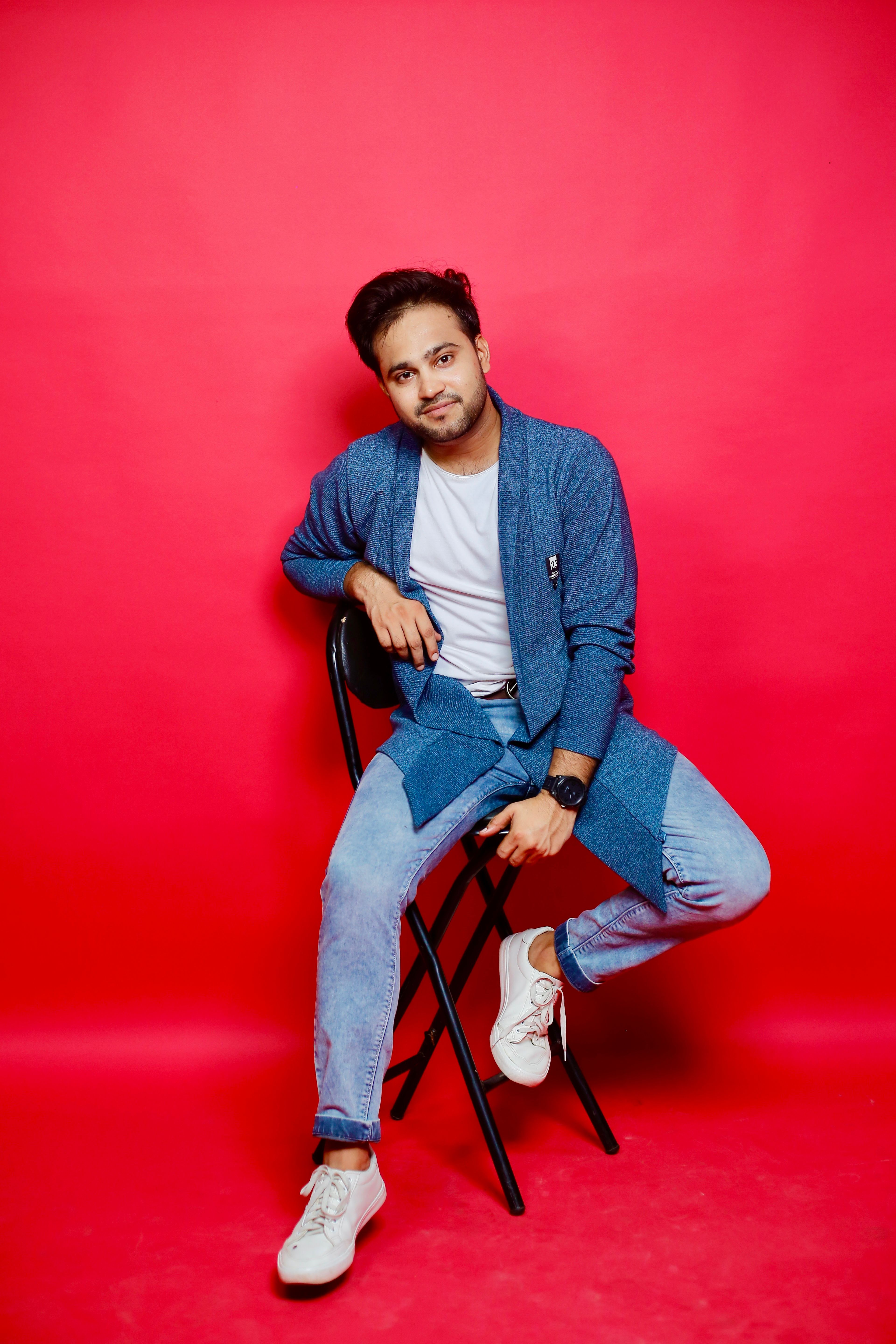 Photograph of a Man Posing on a Chair · Free Stock Photo