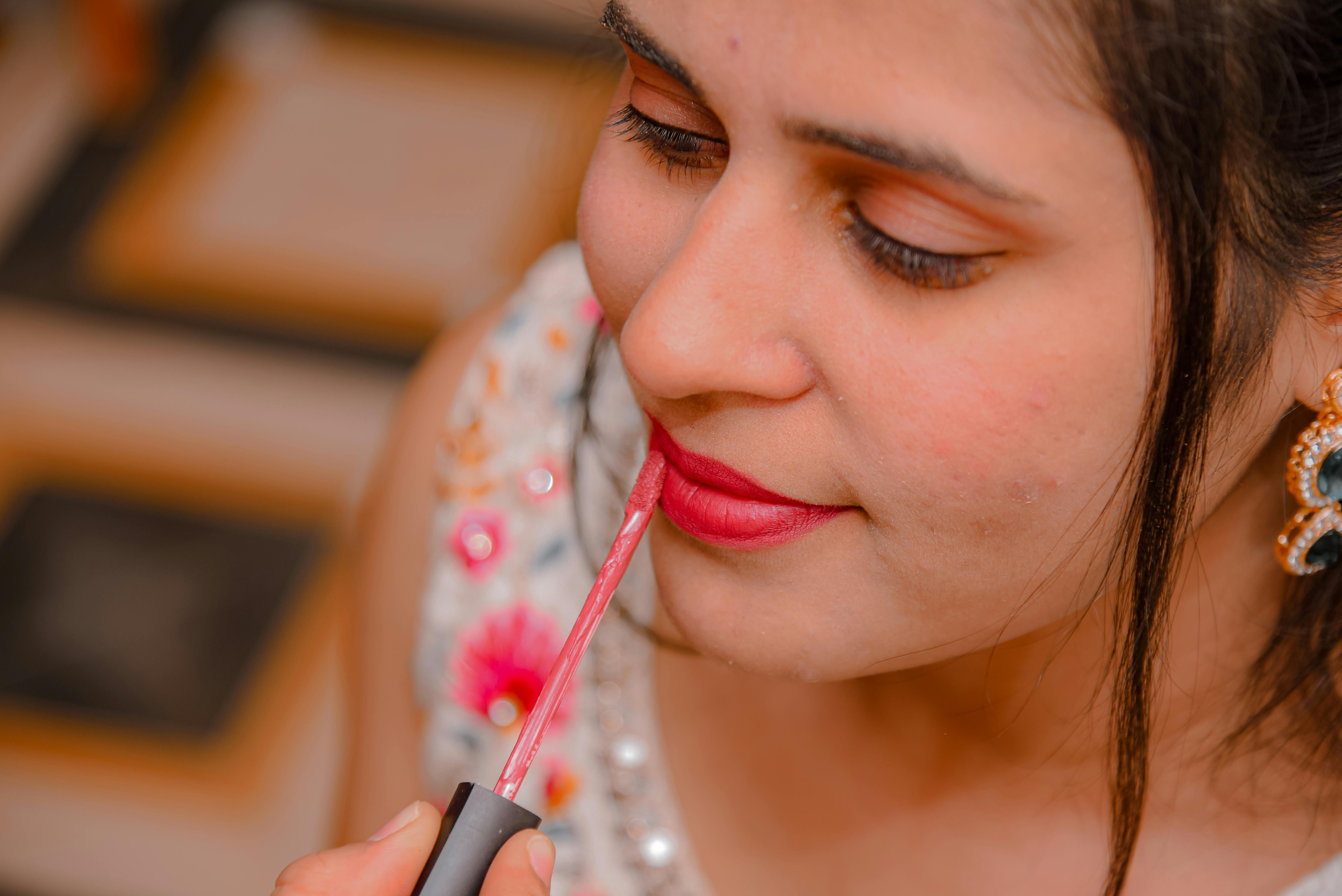Woman Applying Lipstick · Free Stock Photo