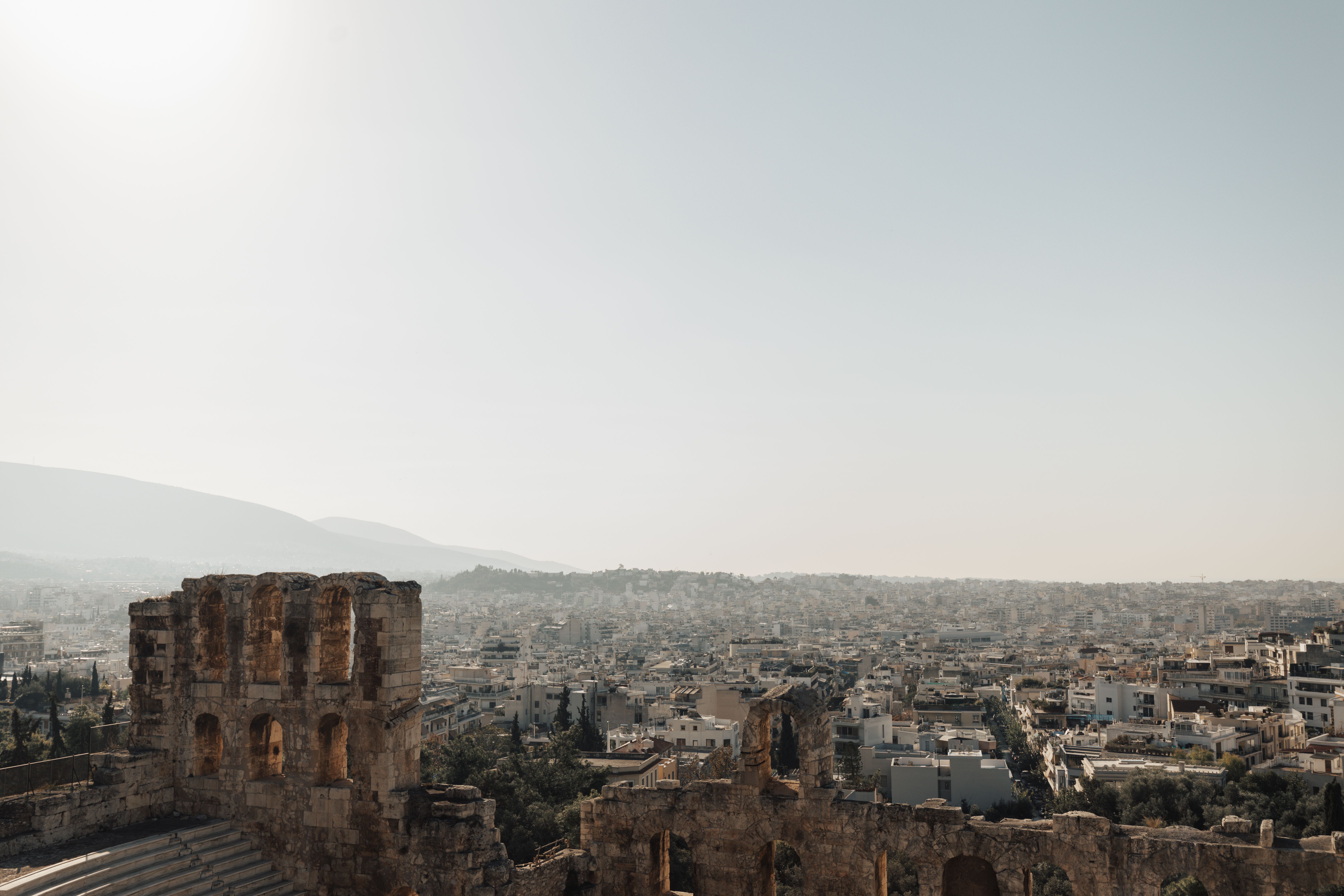 Ancient Ruins Overlooking Vibrant Cityscape · Free Stock Photo